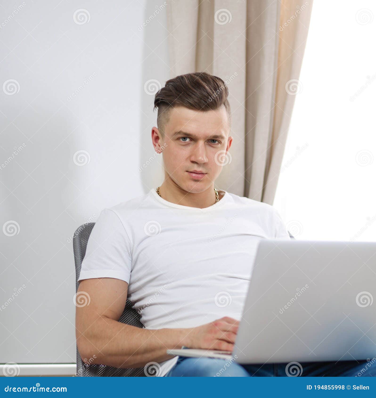 Handsome Young Man Sitting and Working on Laptop Computer Stock Photo ...