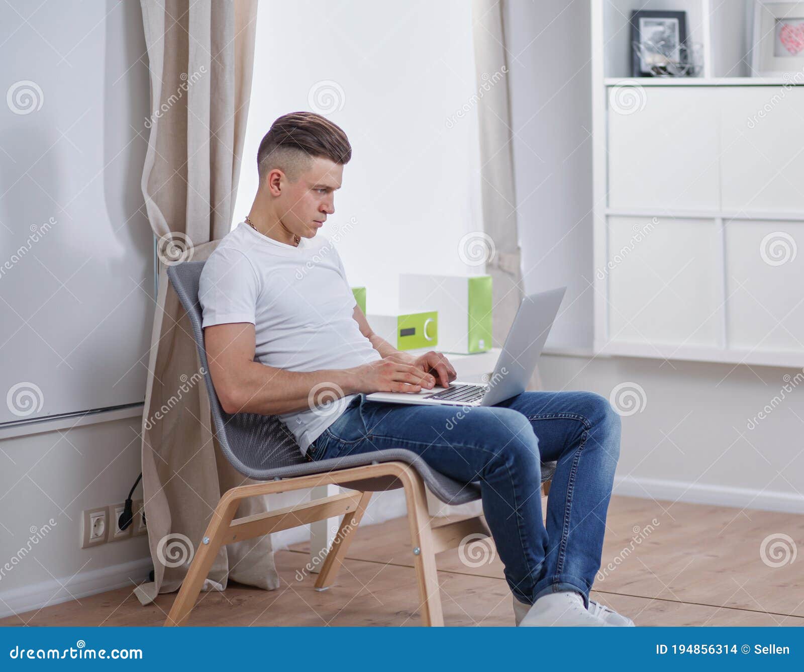 Handsome Young Man Sitting and Working on Laptop Computer Stock Photo ...
