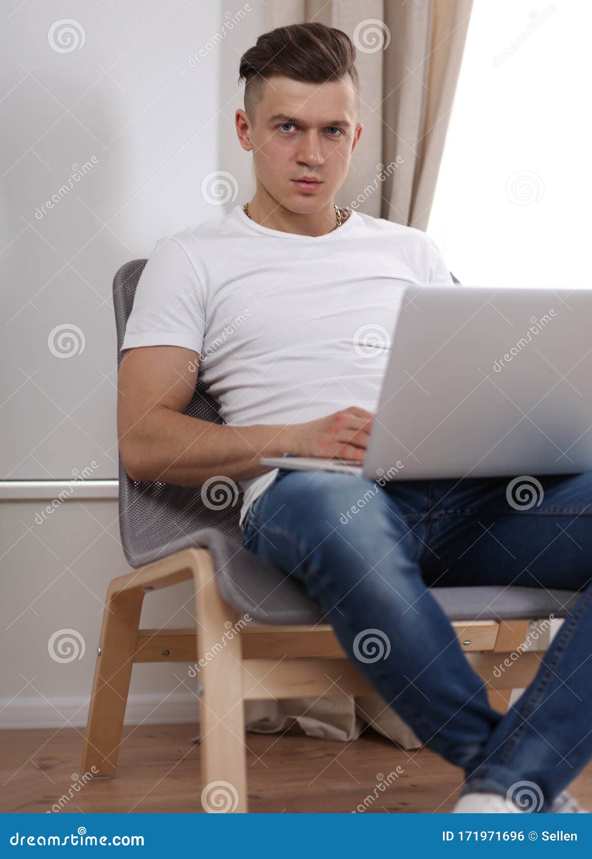 Handsome Young Man Sitting and Working on Laptop Computer Stock Photo ...