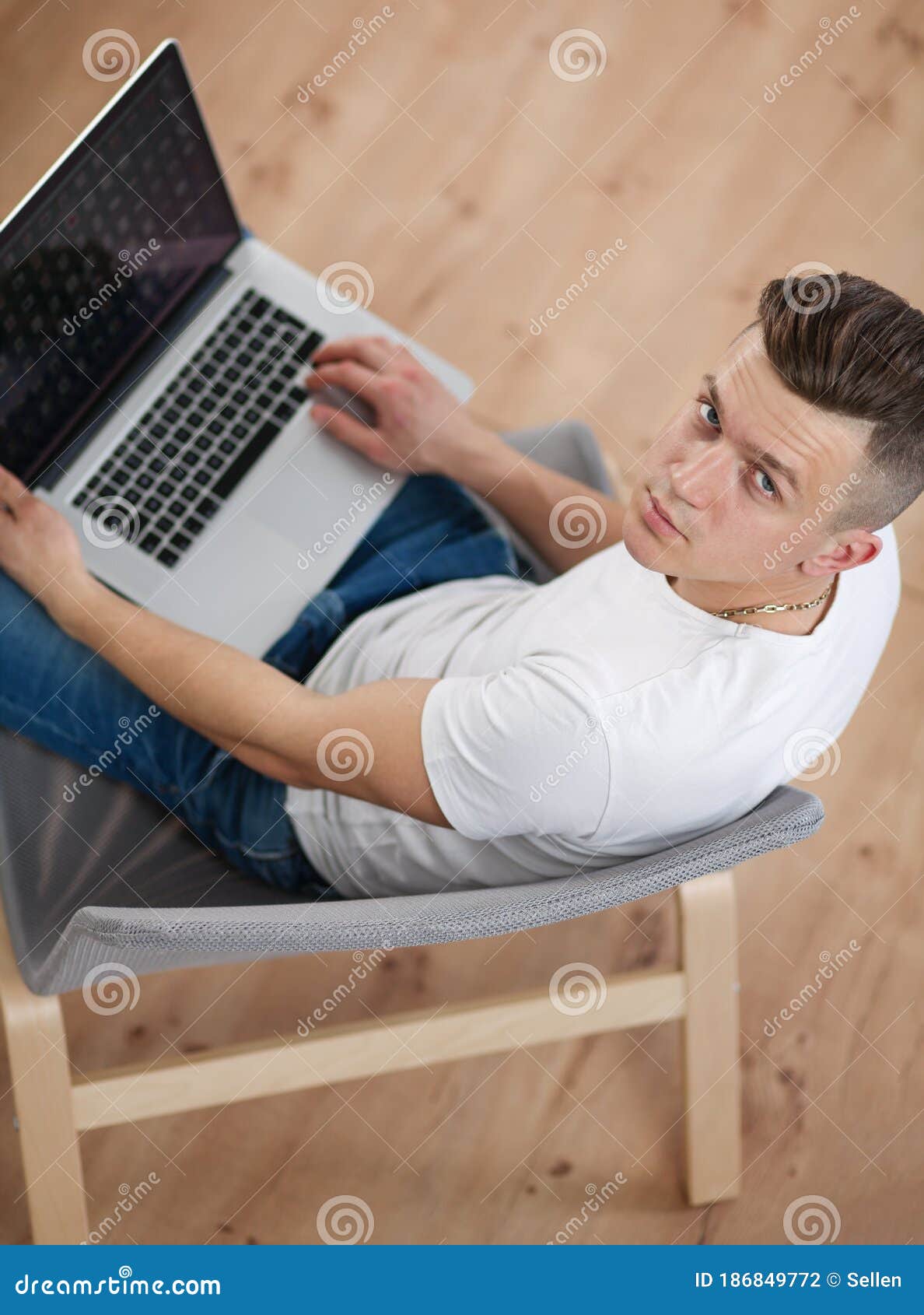 Handsome Young Man Sitting and Working on Laptop Computer Stock Photo ...