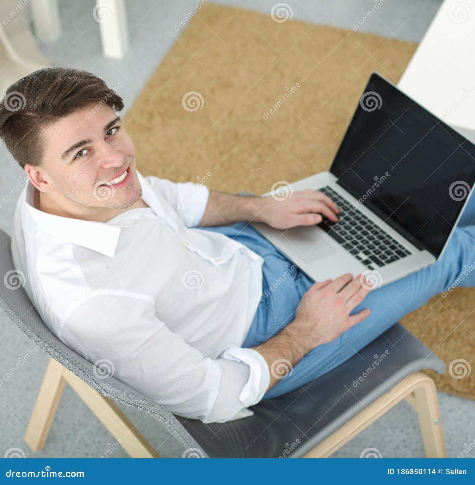Handsome Young Man Sitting and Working on Laptop Computer Stock Photo ...