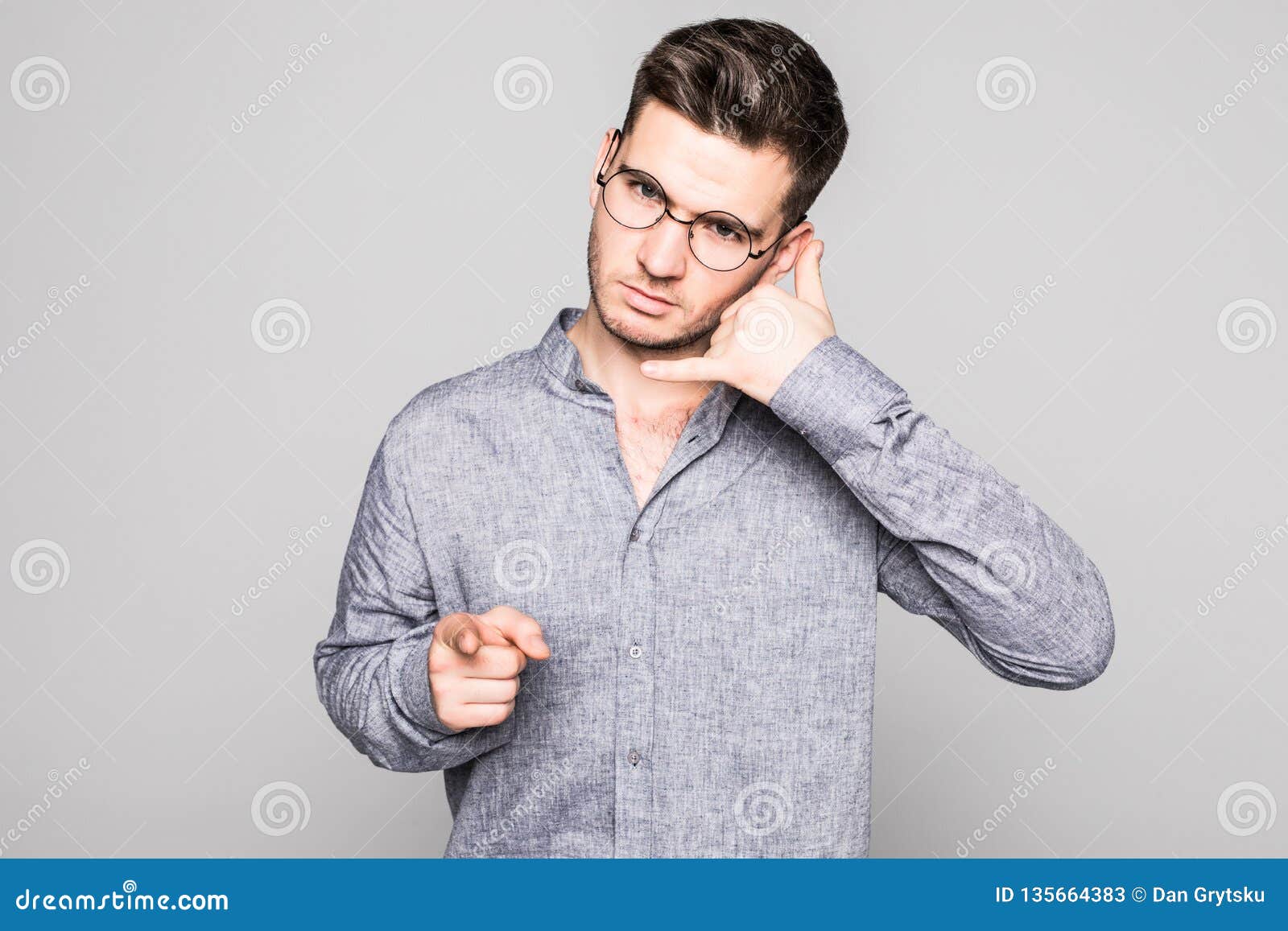 Handsome Cheerful Young Man Smiling and Showing Call Me Back with His ... Handsome Cheerful Young Man Smiling and Showing Call Me Back with His ...