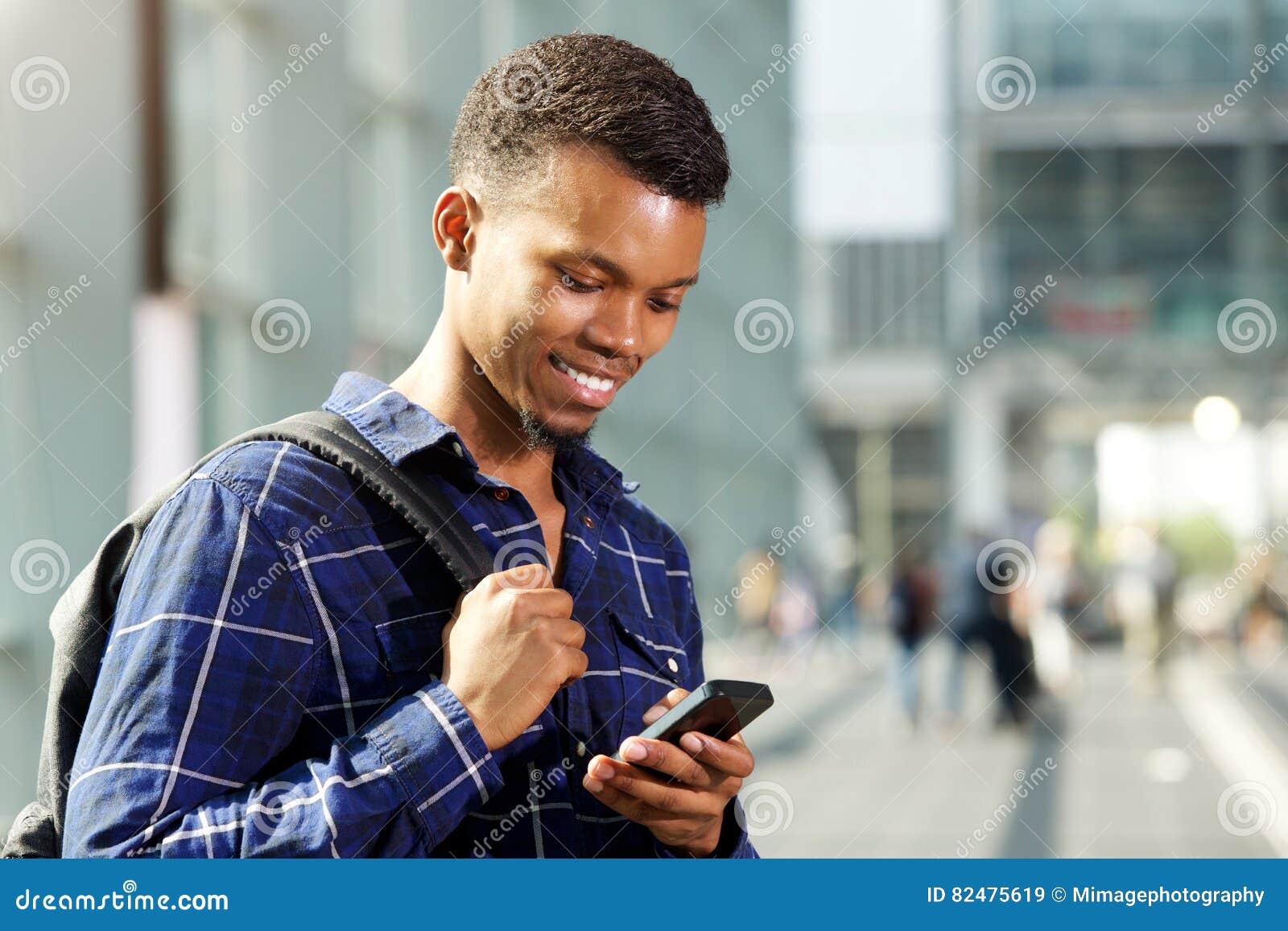 Handsome Young Man Smiling and Using Smart Phone Stock Image - Image of ...