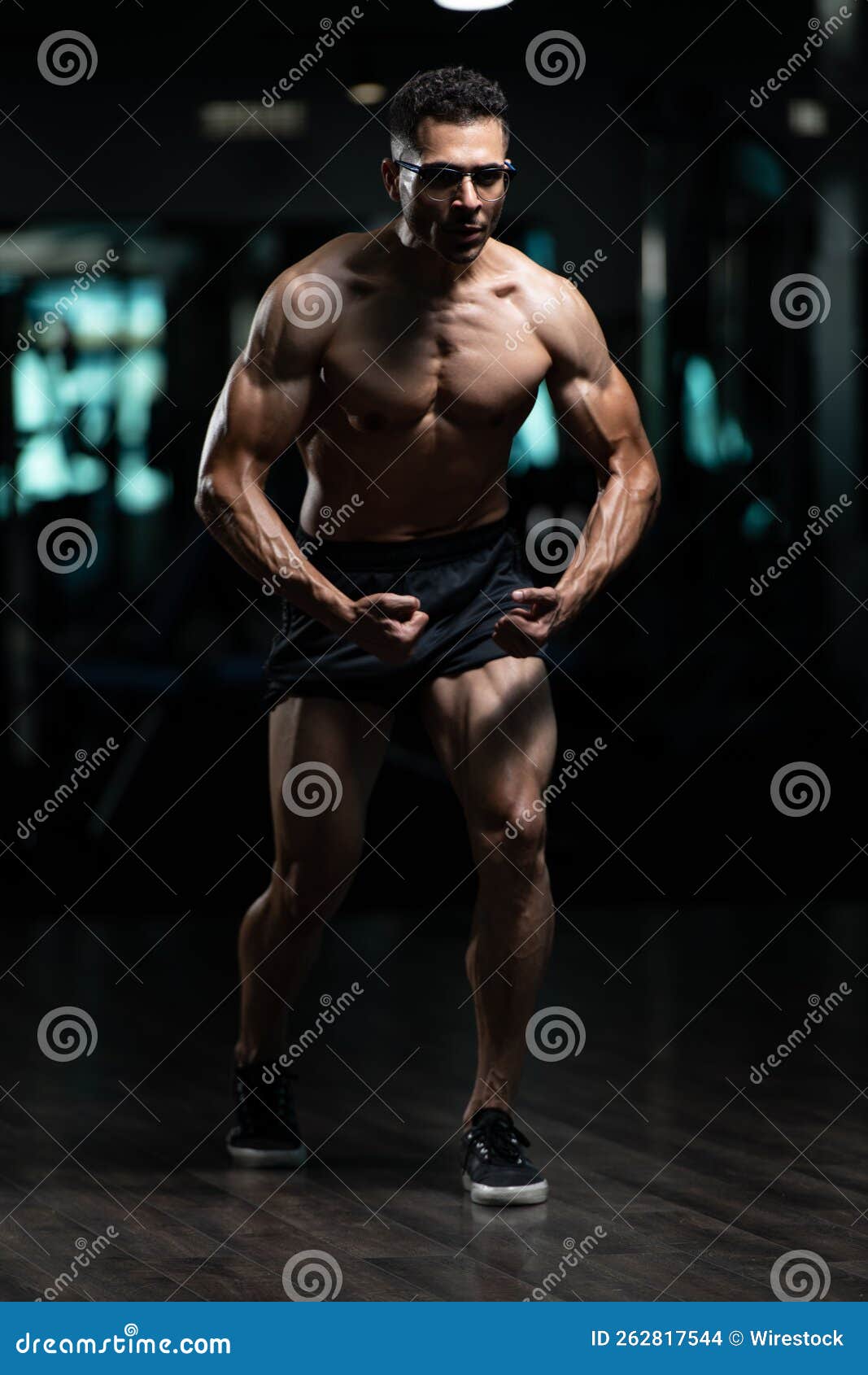 Handsome Young Man Standing Strong and Flexing Muscles in Gym Stock ...