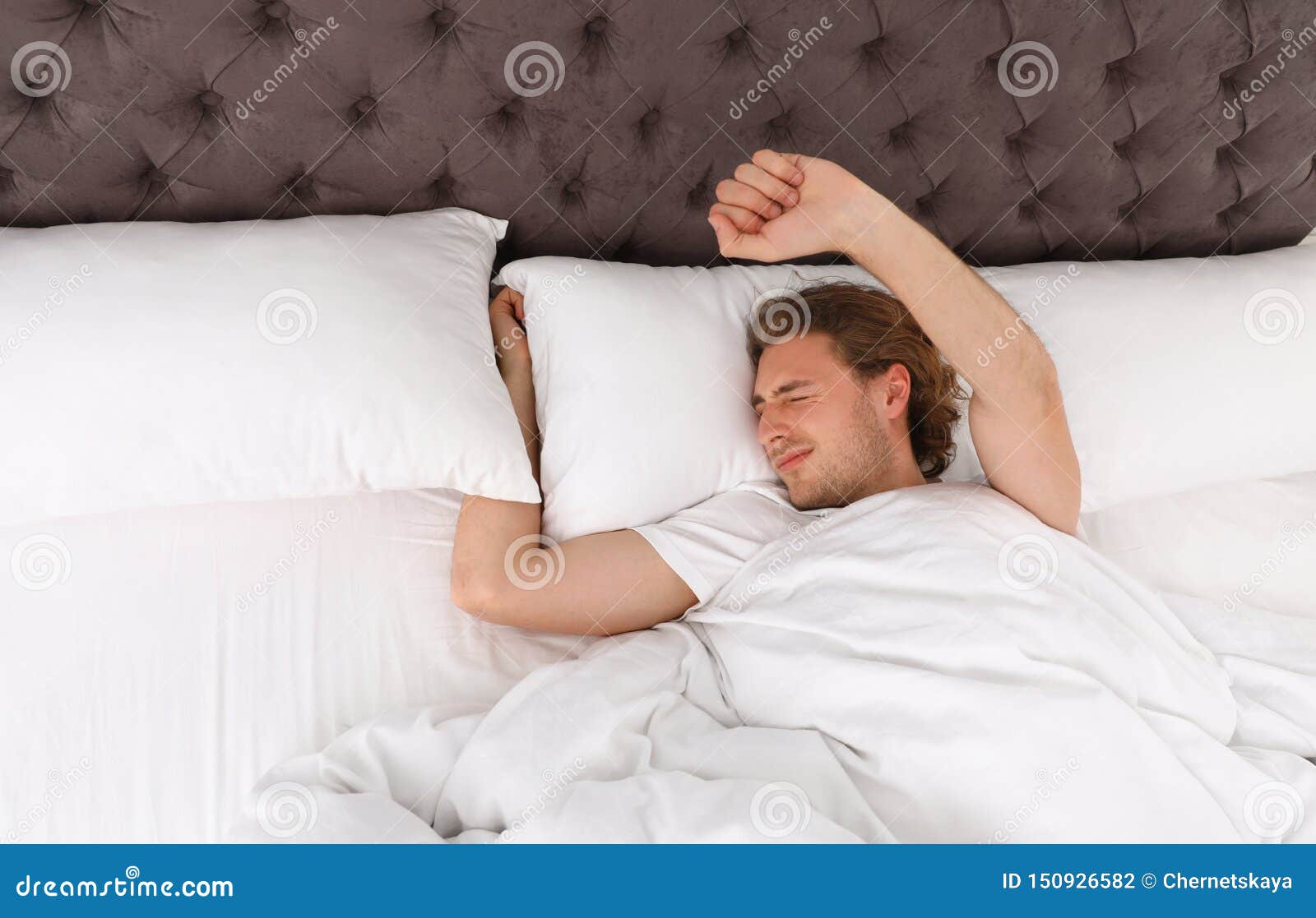 Handsome Young Man Stretching while Lying Under Blanket. Bedtime Stock ... Handsome Young Man Stretching while Lying Under Blanket. Bedtime Stock ...