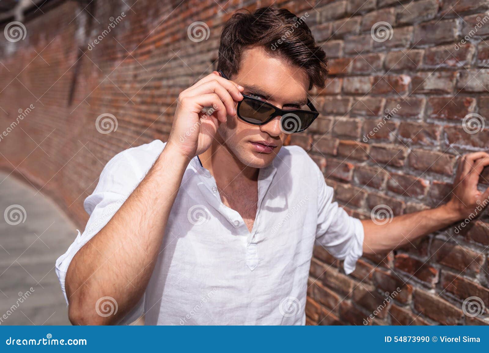 Handsome Young Man Taking Off His Sunglasses. Stock Photo - Image of ...