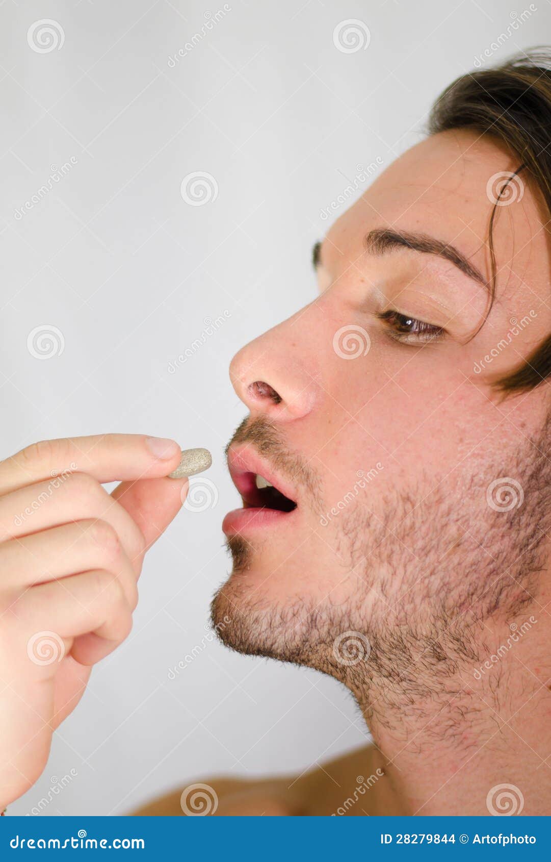 Handsome Young Man Taking Pill or Medicine Capsule Stock Photo - Image ...