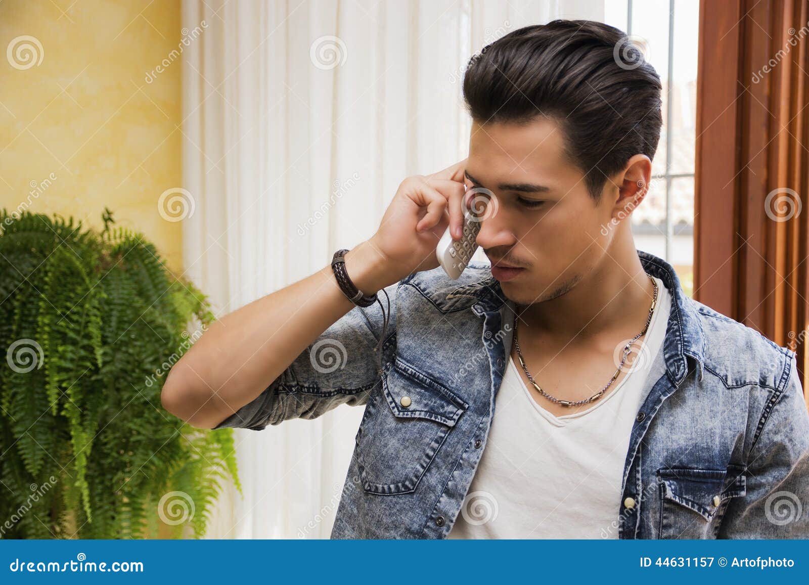 Handsome Young Man Talking on Telephone Inside House Stock Image ...