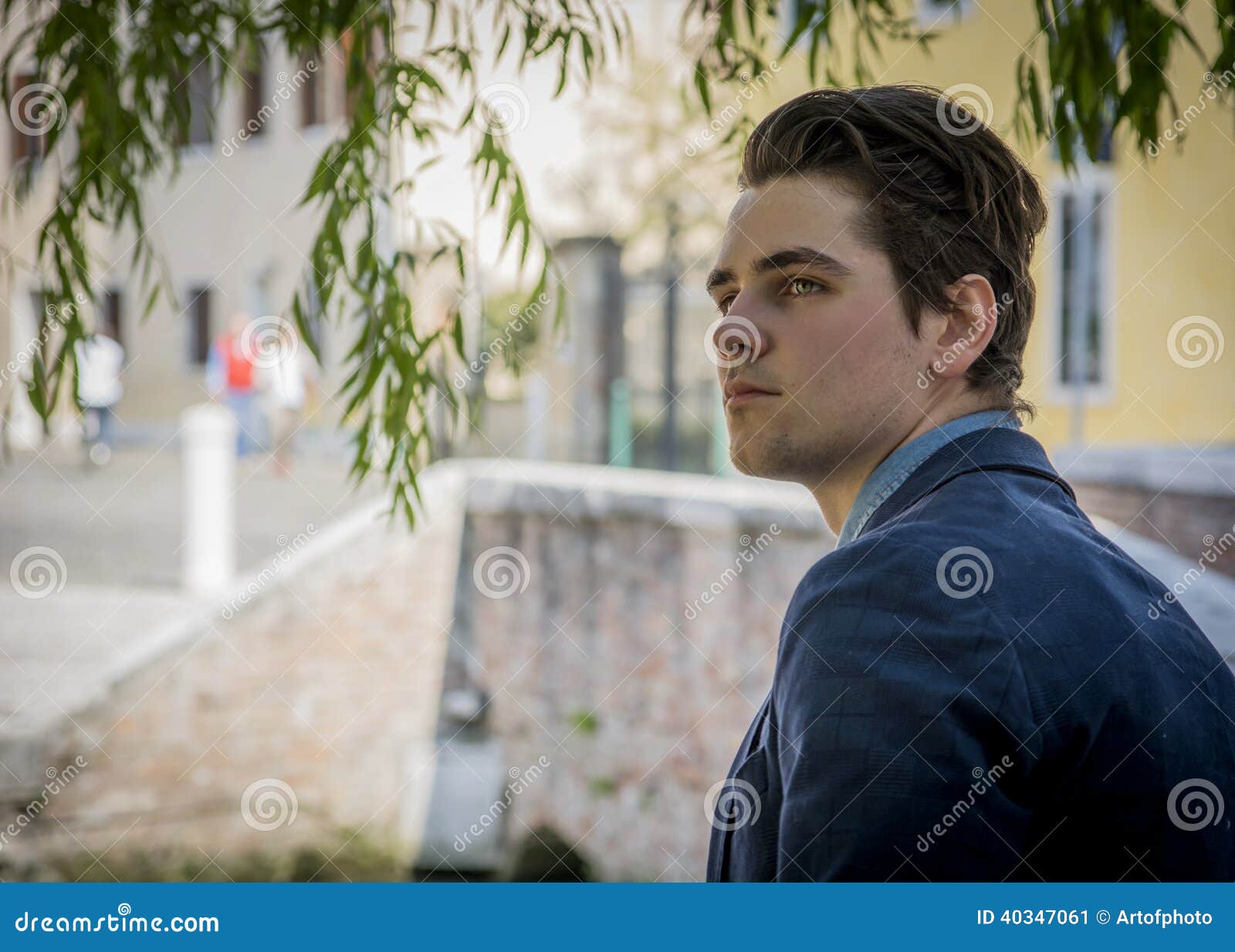 Handsome Young Man Under a Tree in Town Setting Stock Image - Image of ...