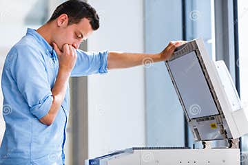 Handsome Young Man Using a Copy Machine Stock Photo - Image of ...