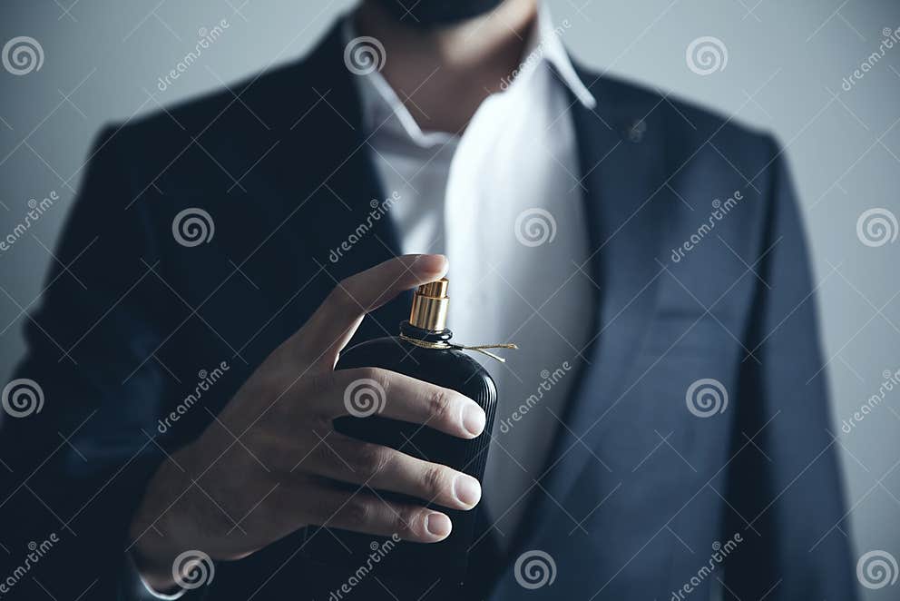 Handsome Young Man Using Perfume Stock Photo - Image of bottle ...