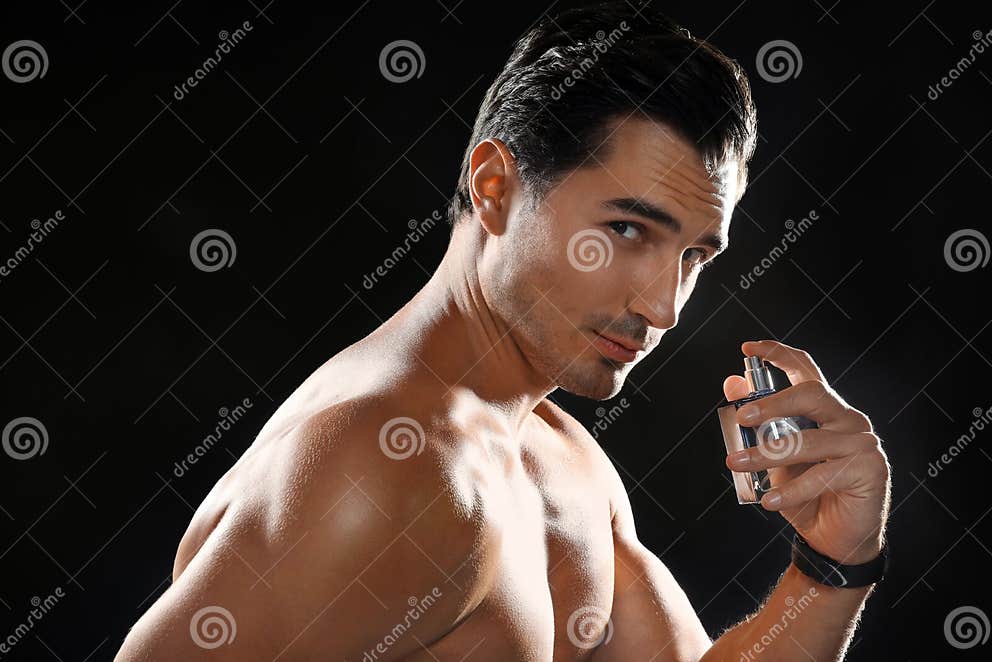 Handsome Young Man Using Perfume on Background Stock Photo - Image of ...