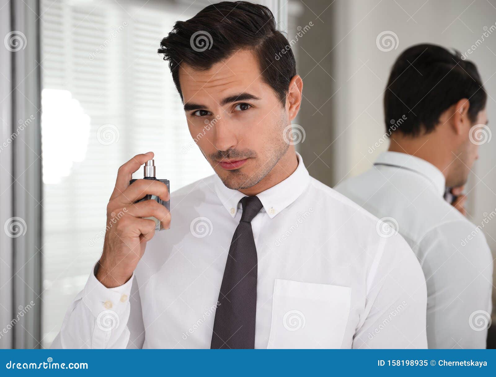 Handsome Young Man Using Perfume Stock Image - Image of beauty, oils ...