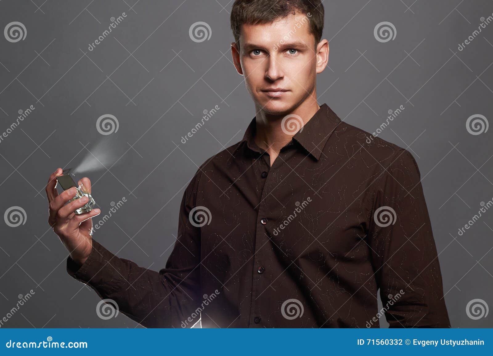 Handsome Young Man Using Perfume.perfume Bottle and Spraying Fragrance ...