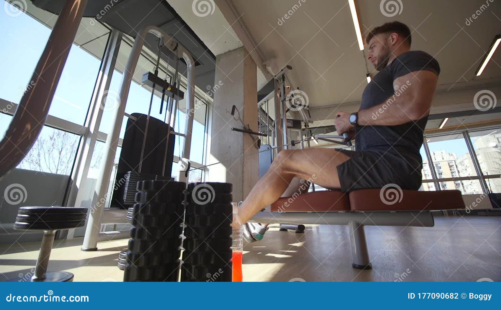 Young Man Using Seated Row Machine in the Gym Stock Footage - Video of ...