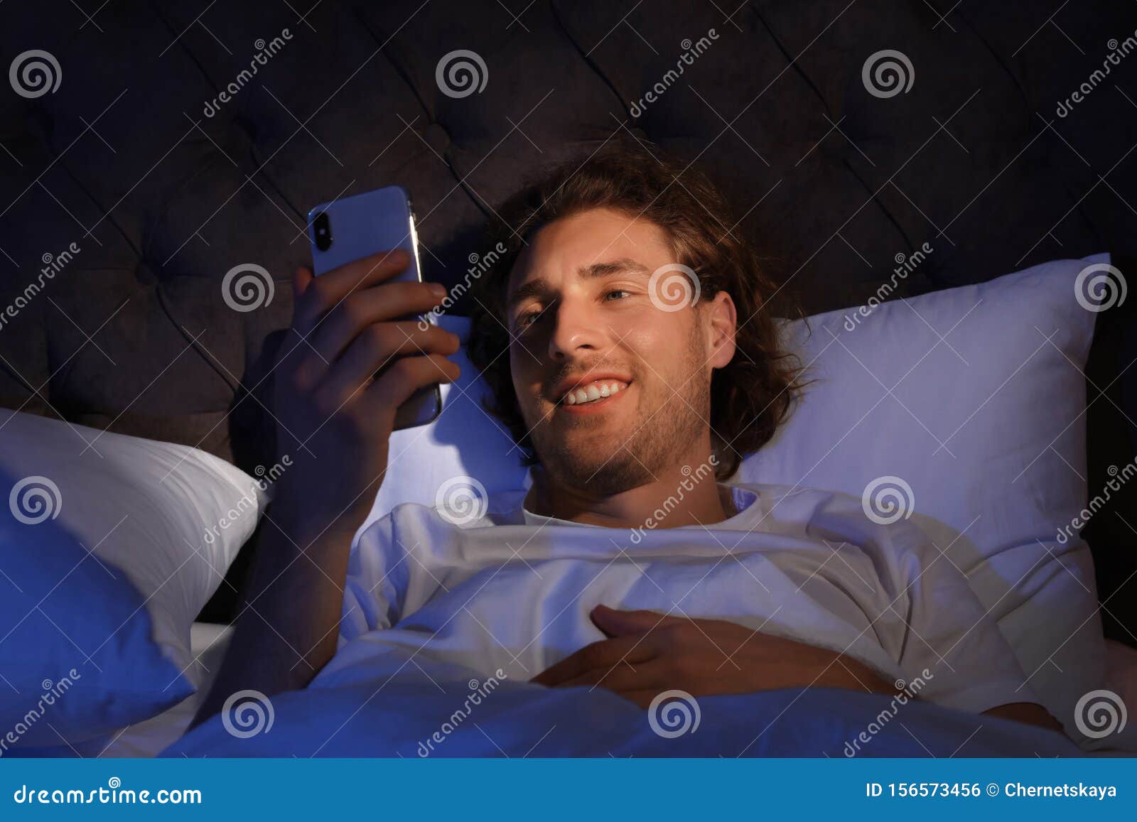 Handsome Young Man Using Smartphone in Dark Room at Night Stock Photo ...