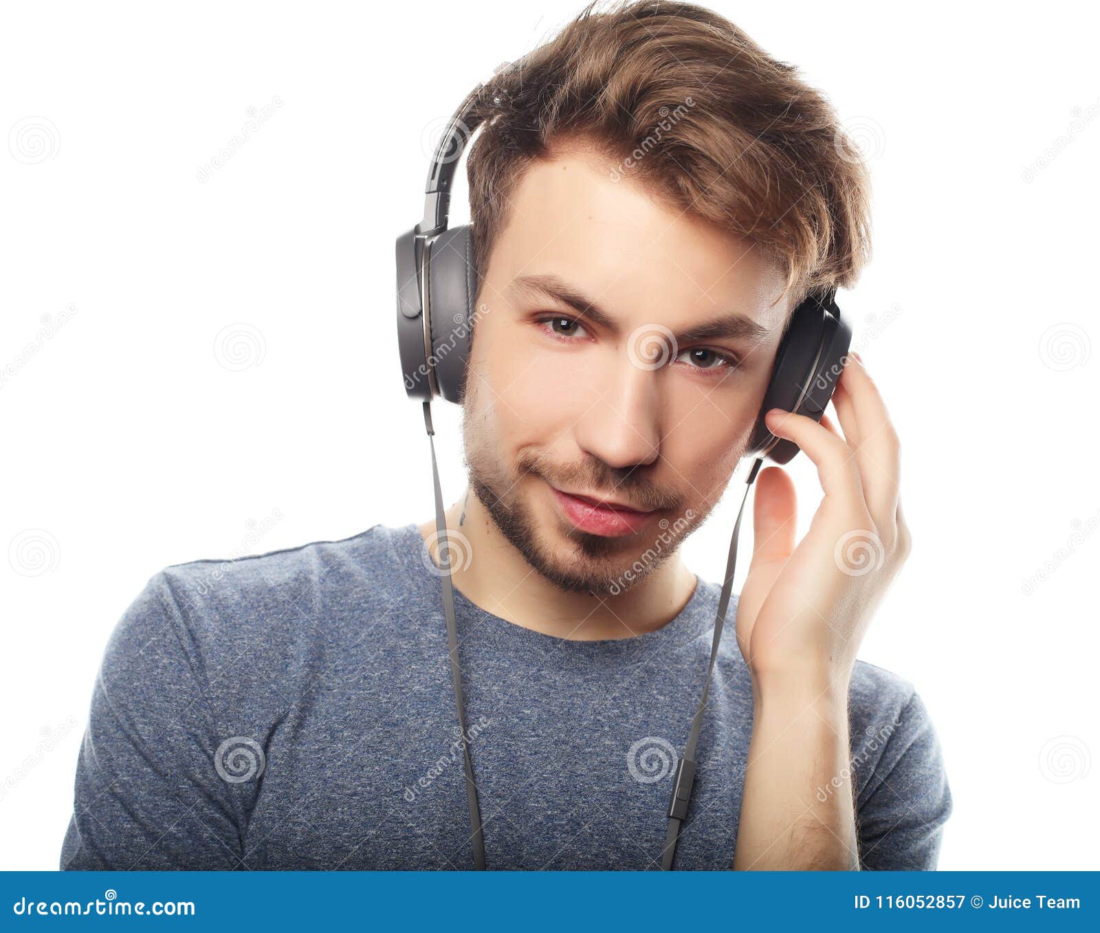 Handsome Young Man Wearing Headphones And Listening To Music Stock