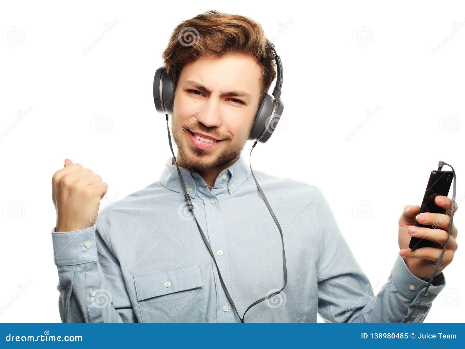 Handsome Young Man Wearing Headphones And Listening To Music Stock