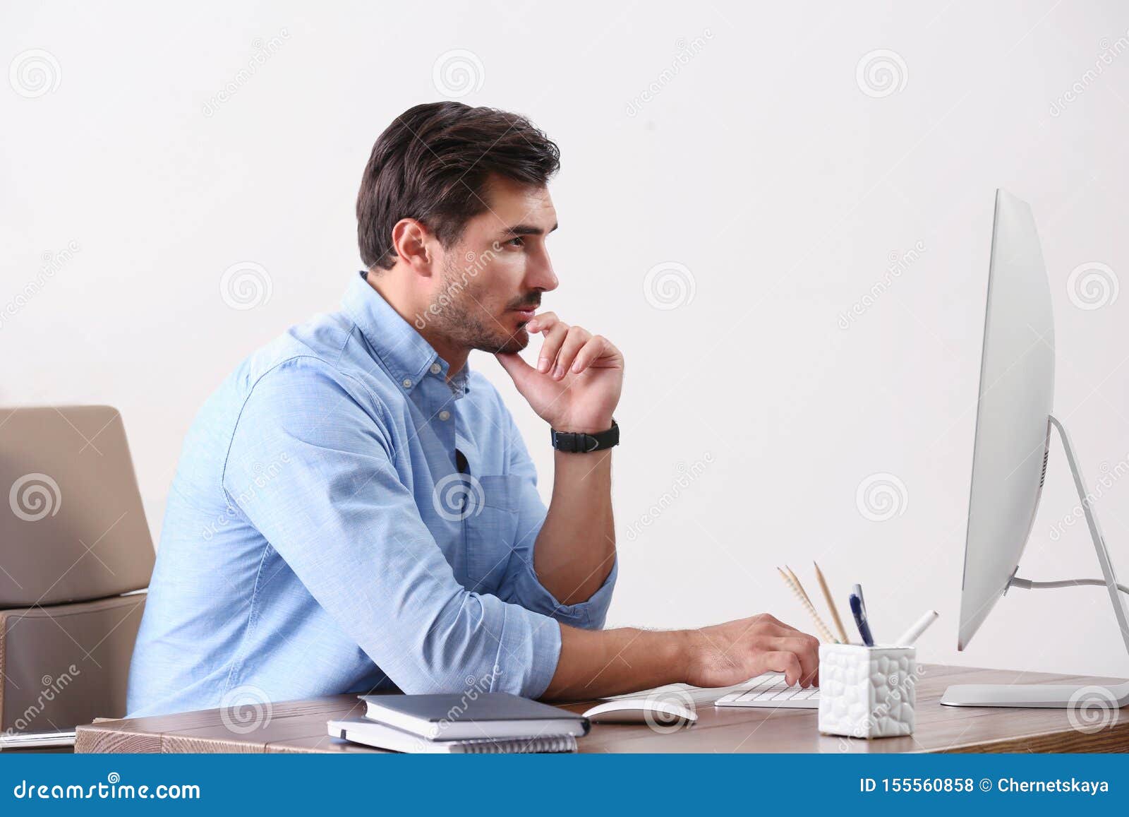 Handsome Young Man Working with Computer at Table in Stock Photo ...