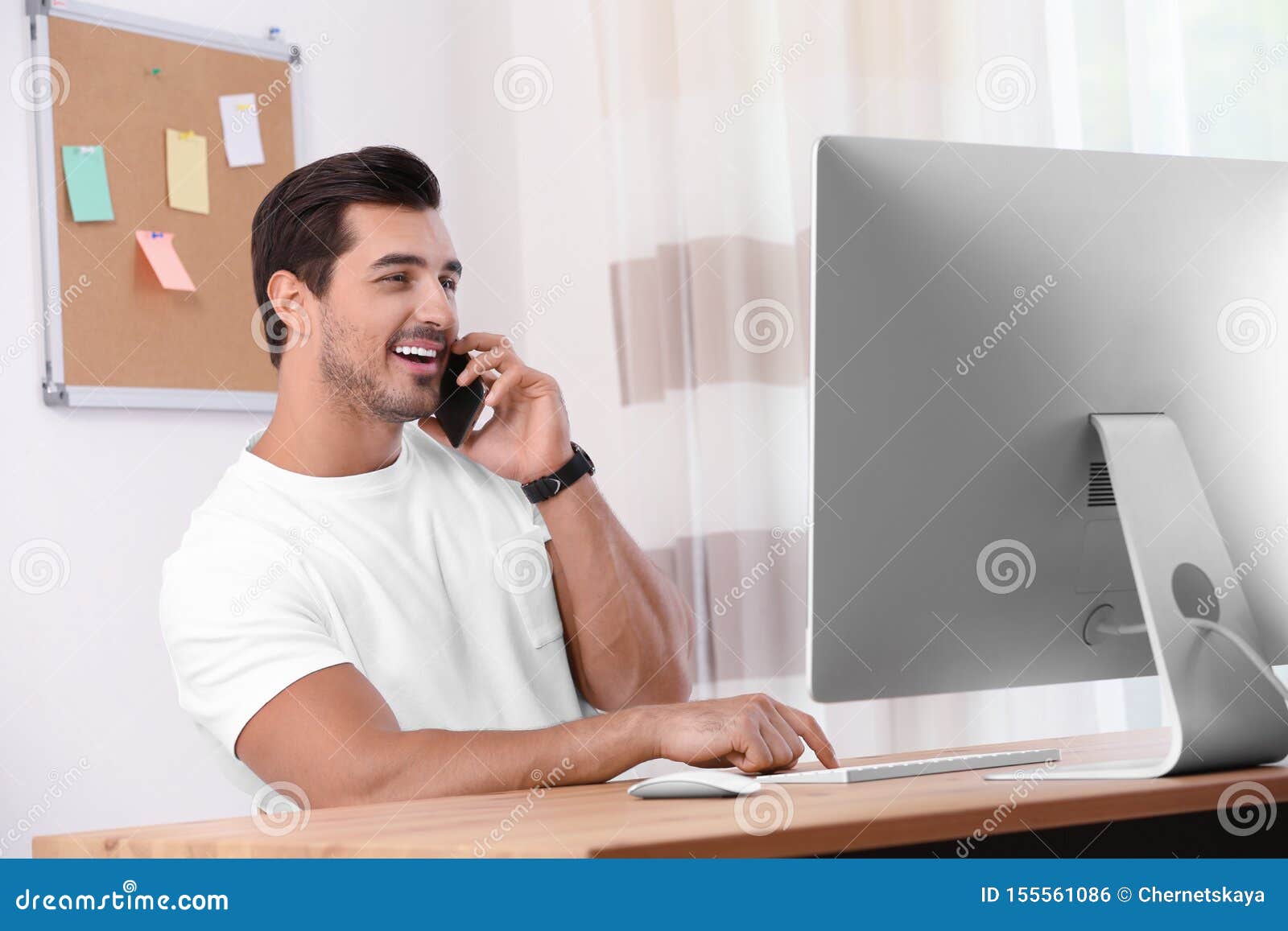 Handsome Young Man Working with and Computer at Table in Office Stock ...