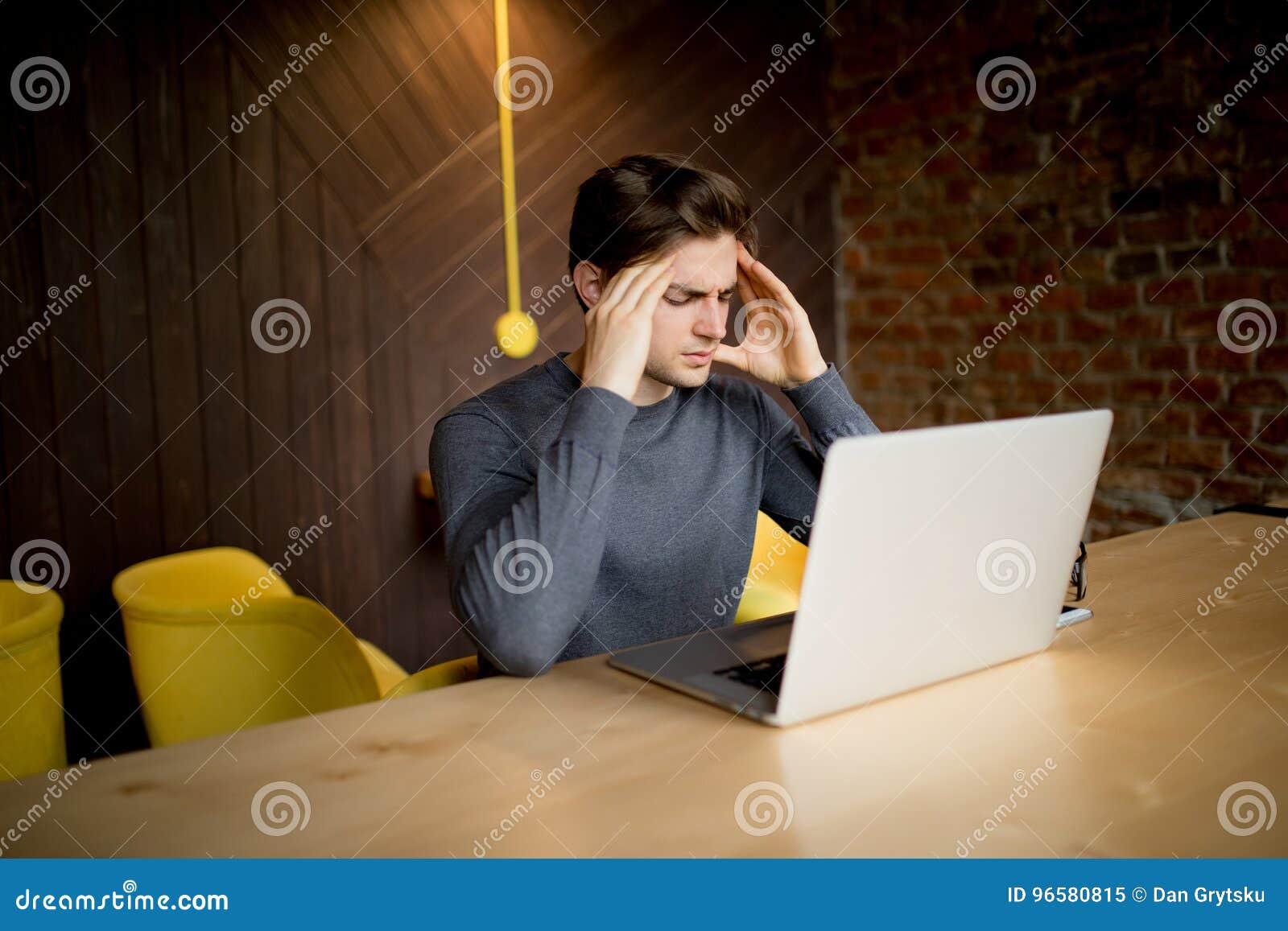 Handsome Young Man Working at Laptop with Sad Face or Head Ache Working ...