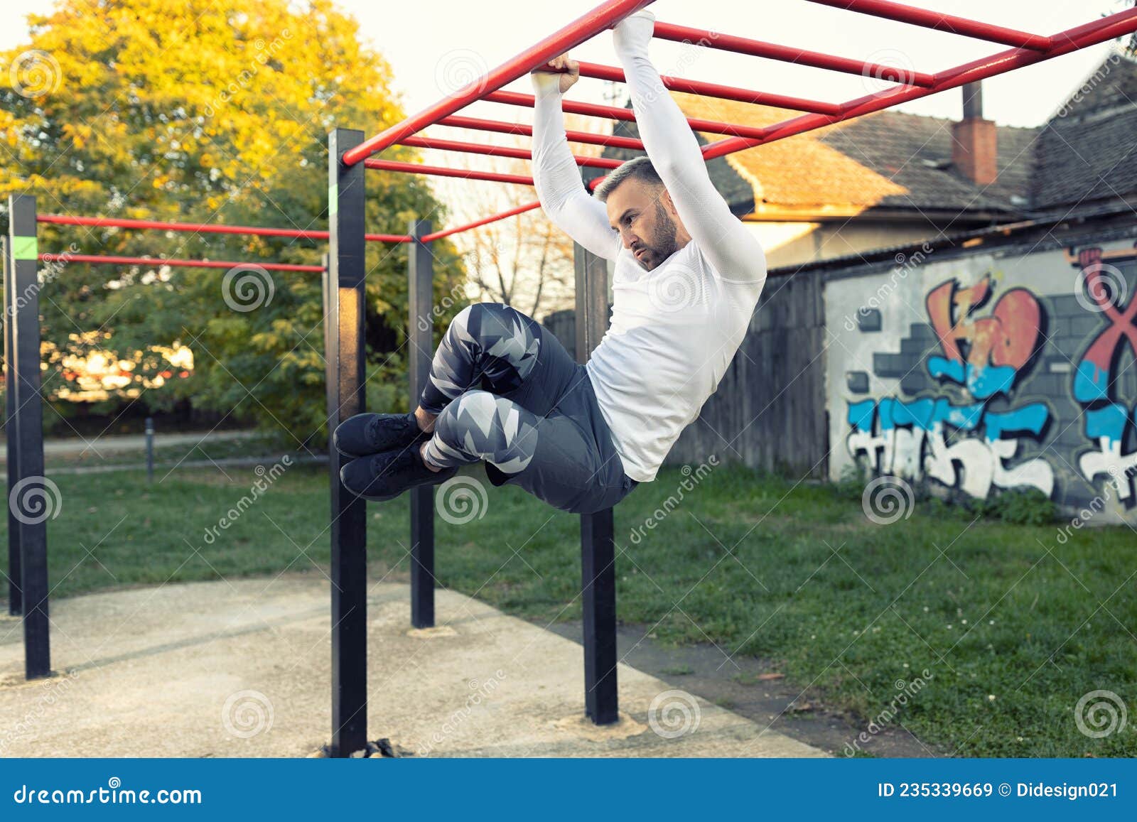 Handsome Young Man Working Out His Abs while Hanging on the Horizontal ...