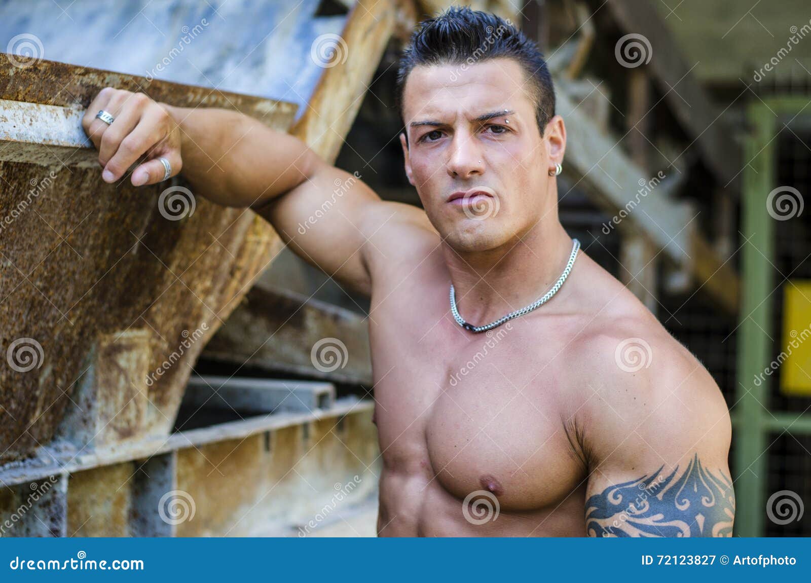 Handsome Young Muscle Man with Hand on Rusty Metal Structure Stock ...