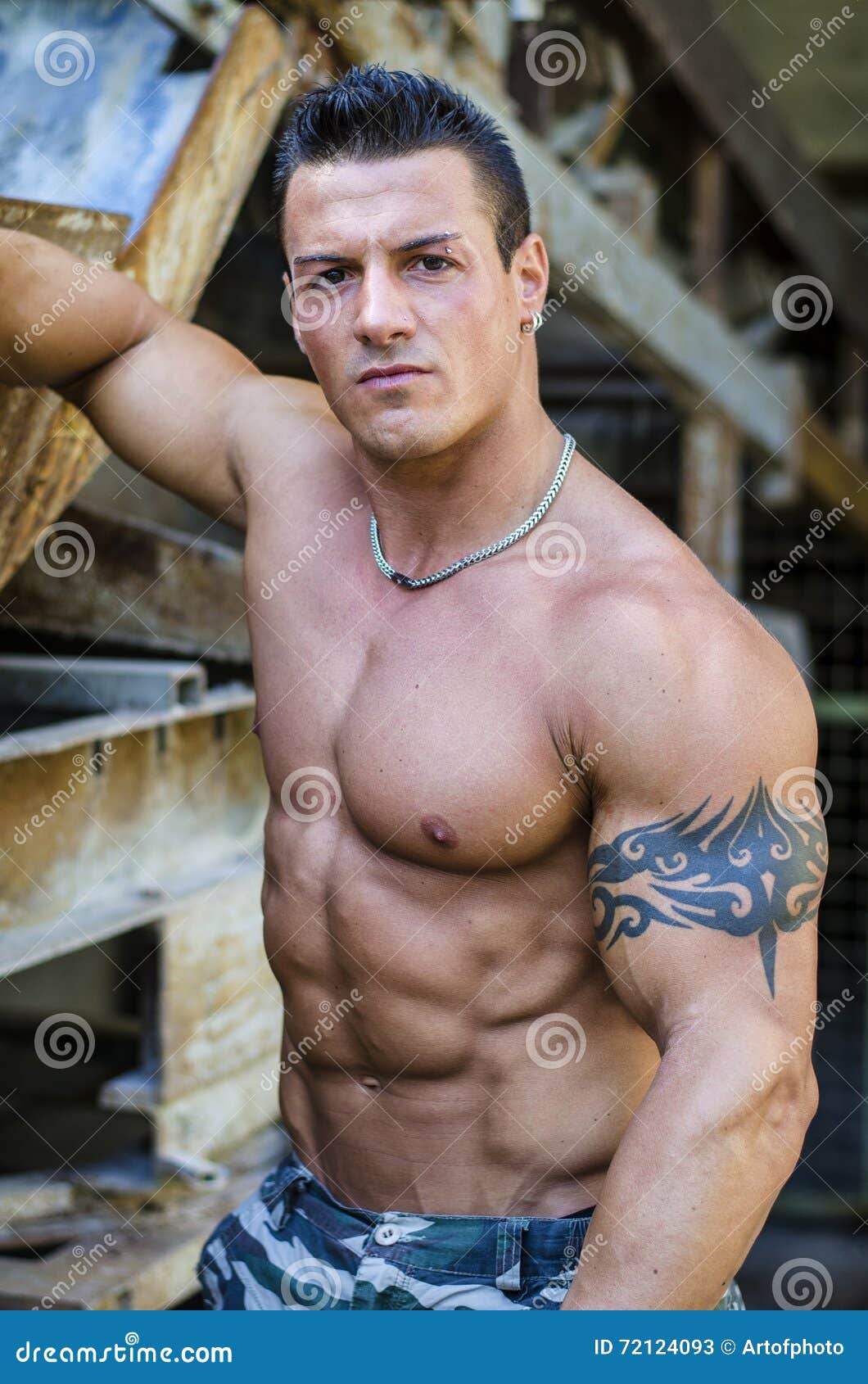 Handsome Young Muscle Man with Hand on Rusty Metal Structure Stock ...