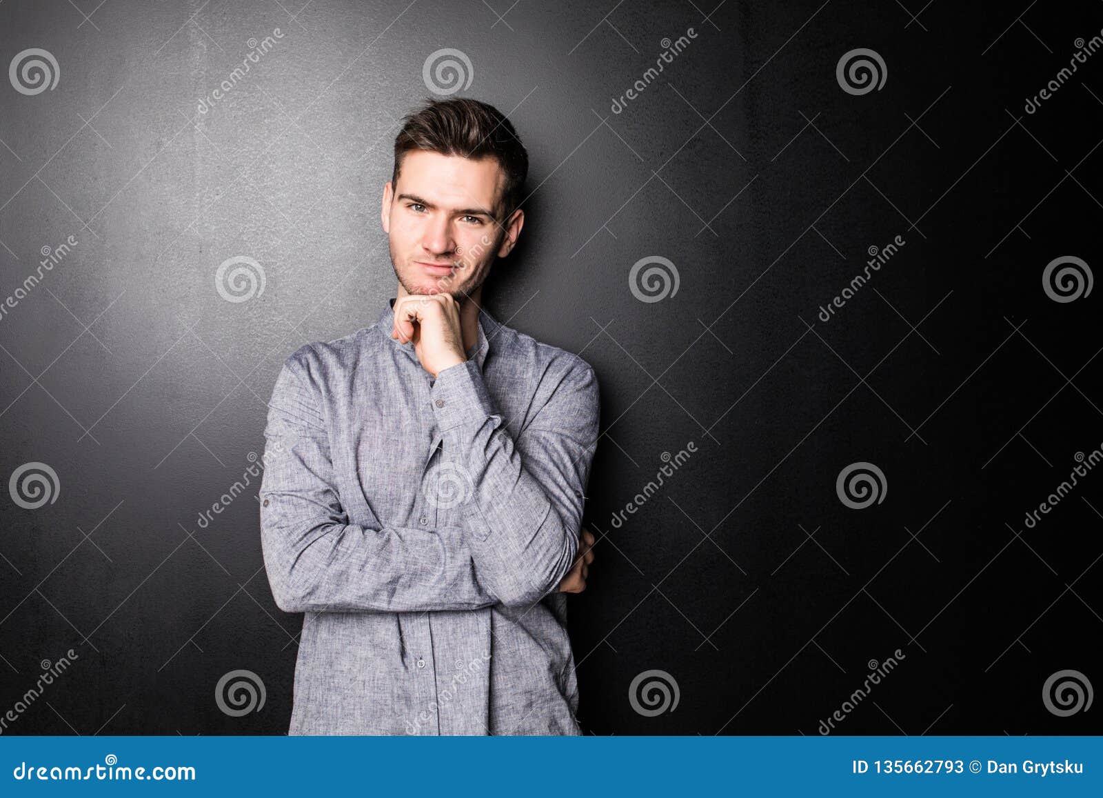 Handsome Young Pensive Man Standing and Looking Up Isolated on the Gray ...
