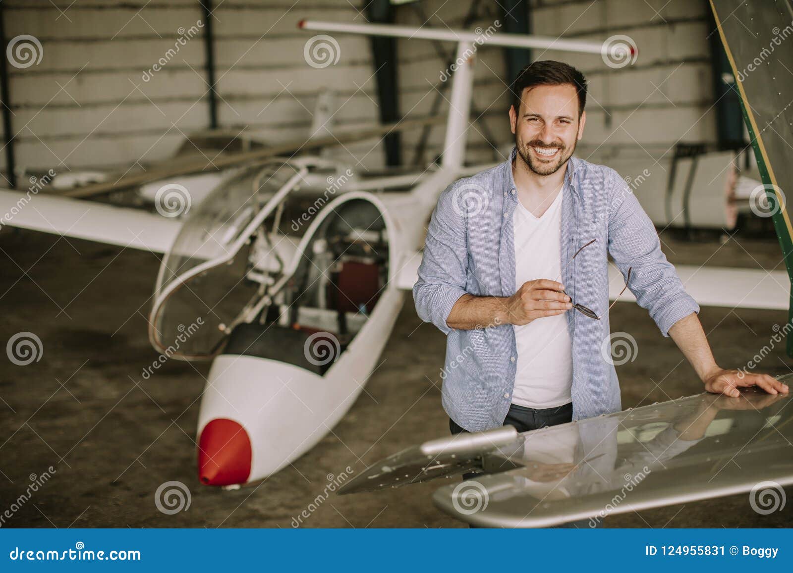 Young Pilot Checking Airplane in the Hangar Stock Image - Image of ...
