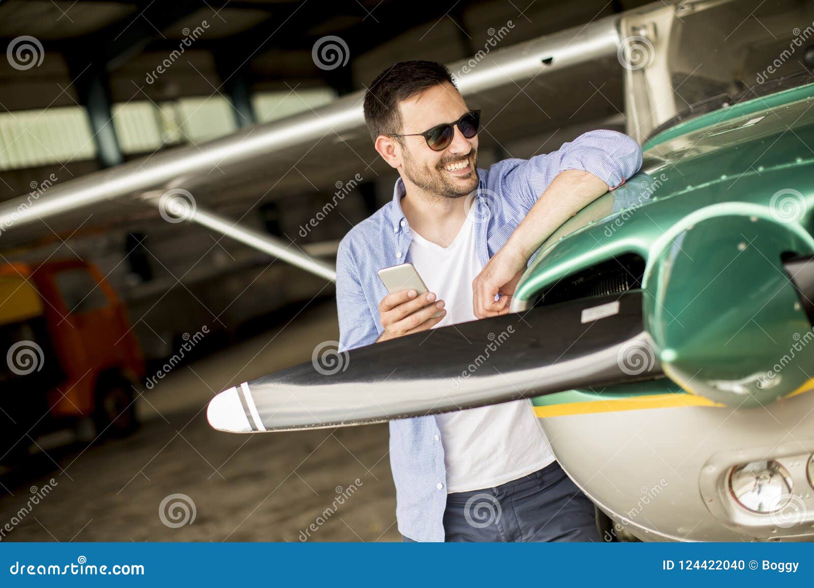 Handsome Young Pilot Checking Airplane in the Hangar and Using M Stock ...