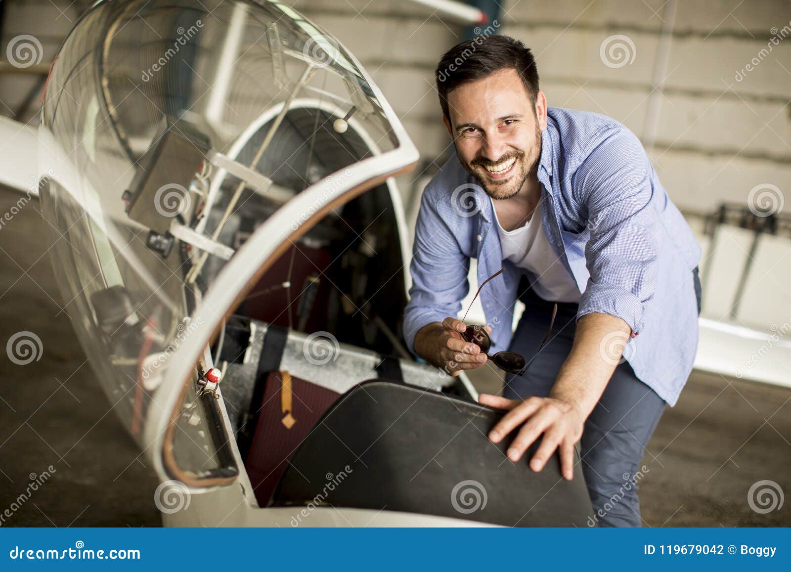 Young Pilot Checking Airplane in the Hangar Stock Photo - Image of ...
