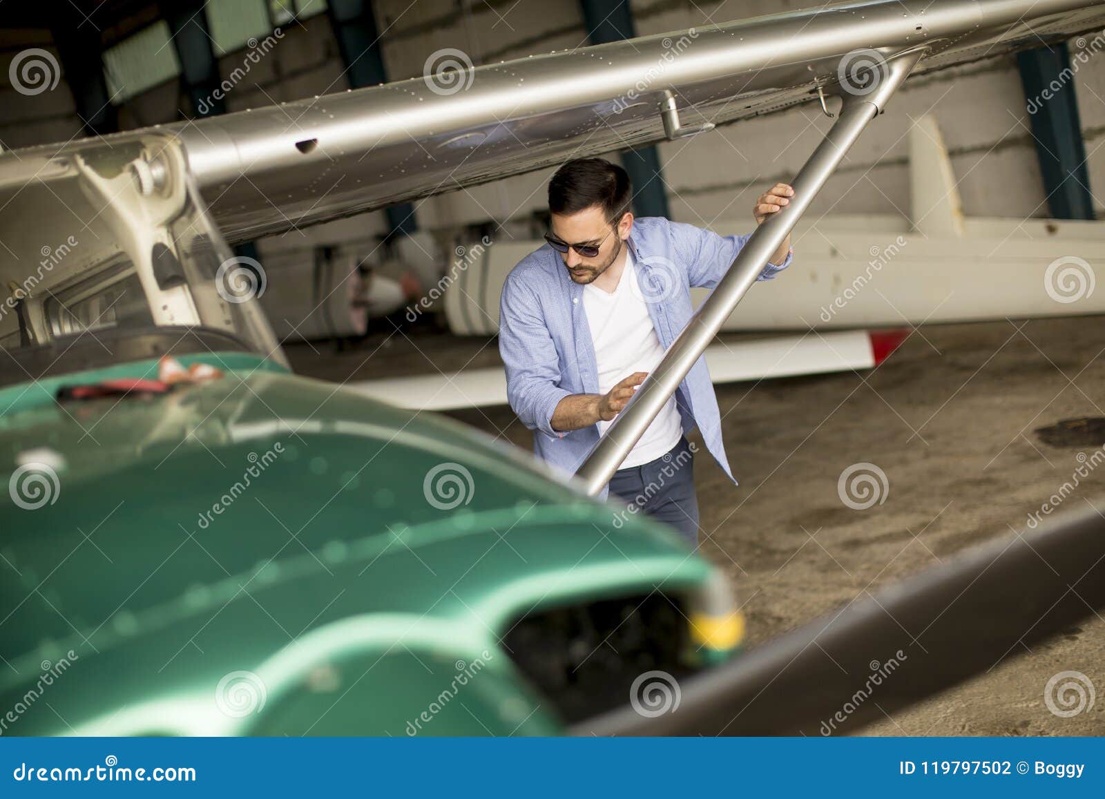 Young Pilot Checking Airplane in the Hangar Stock Photo - Image of ...
