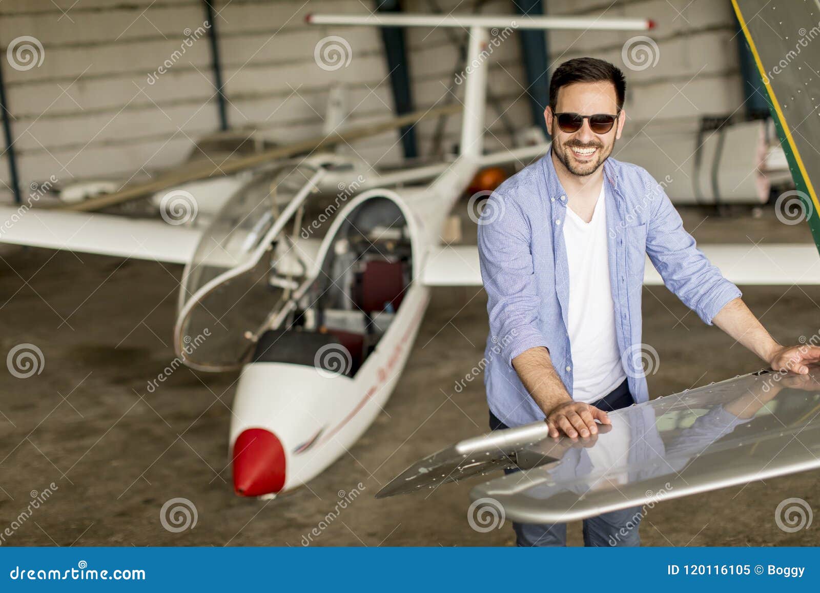 Young Pilot Checking Airplane in the Hangar Stock Image - Image of ...
