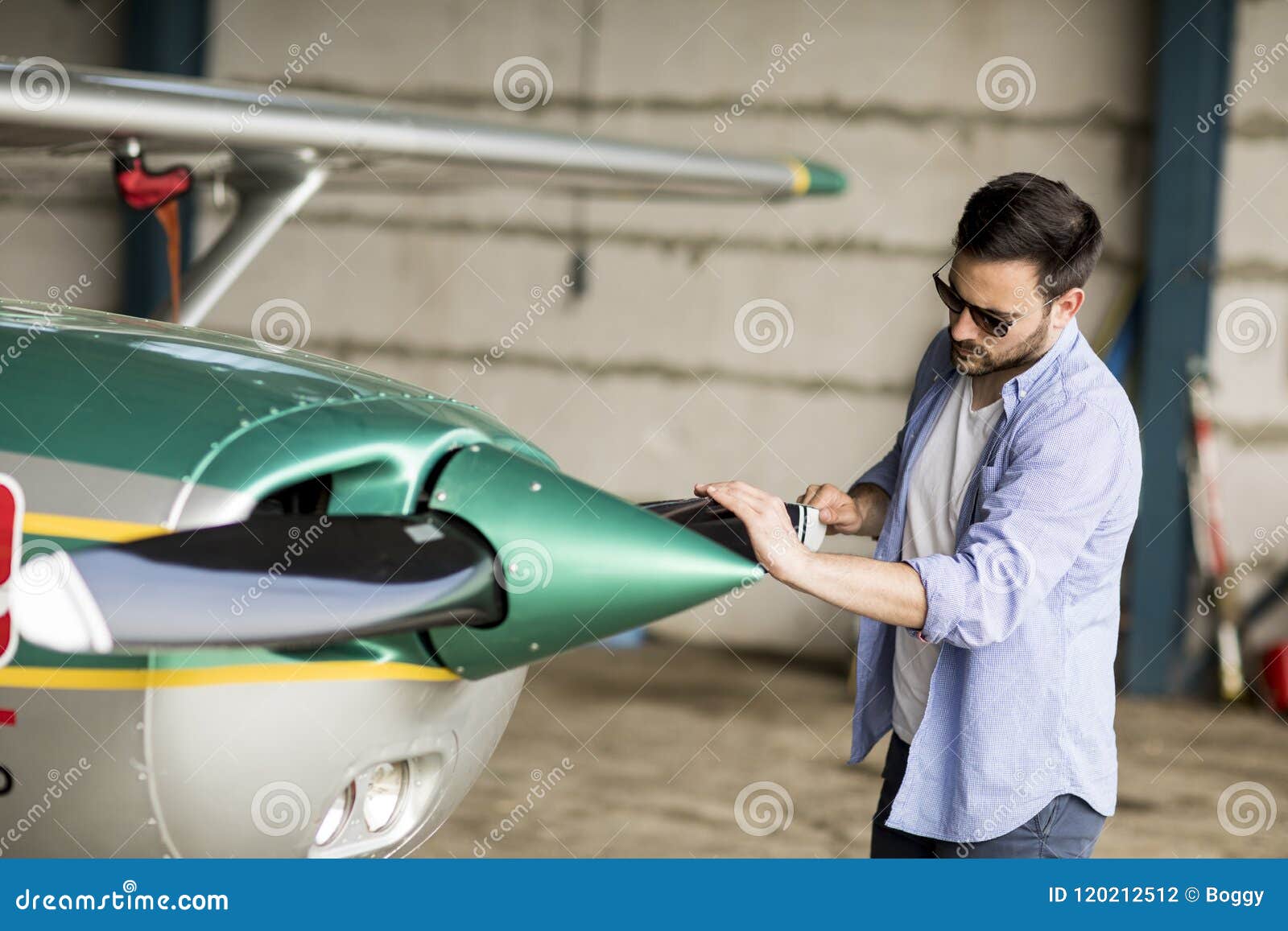 Young Pilot Checking Airplane in the Hangar Stock Photo - Image of ...