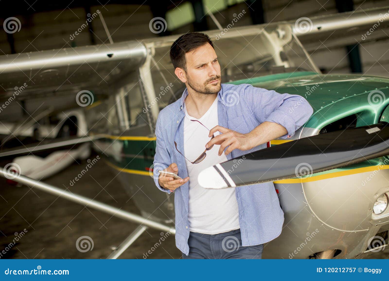 Young Pilot Checking Airplane in the Hangar Stock Image - Image of ...