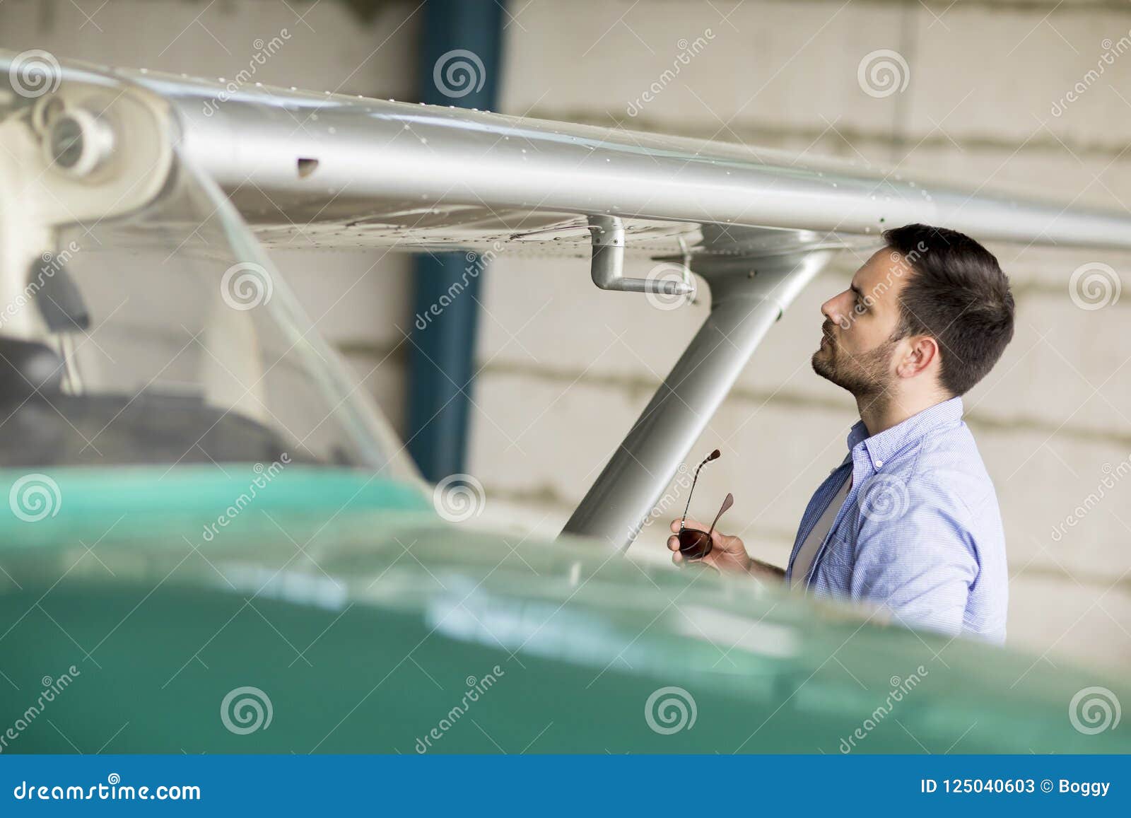 Young Pilot Checking Airplane in the Hangar Stock Image - Image of ...