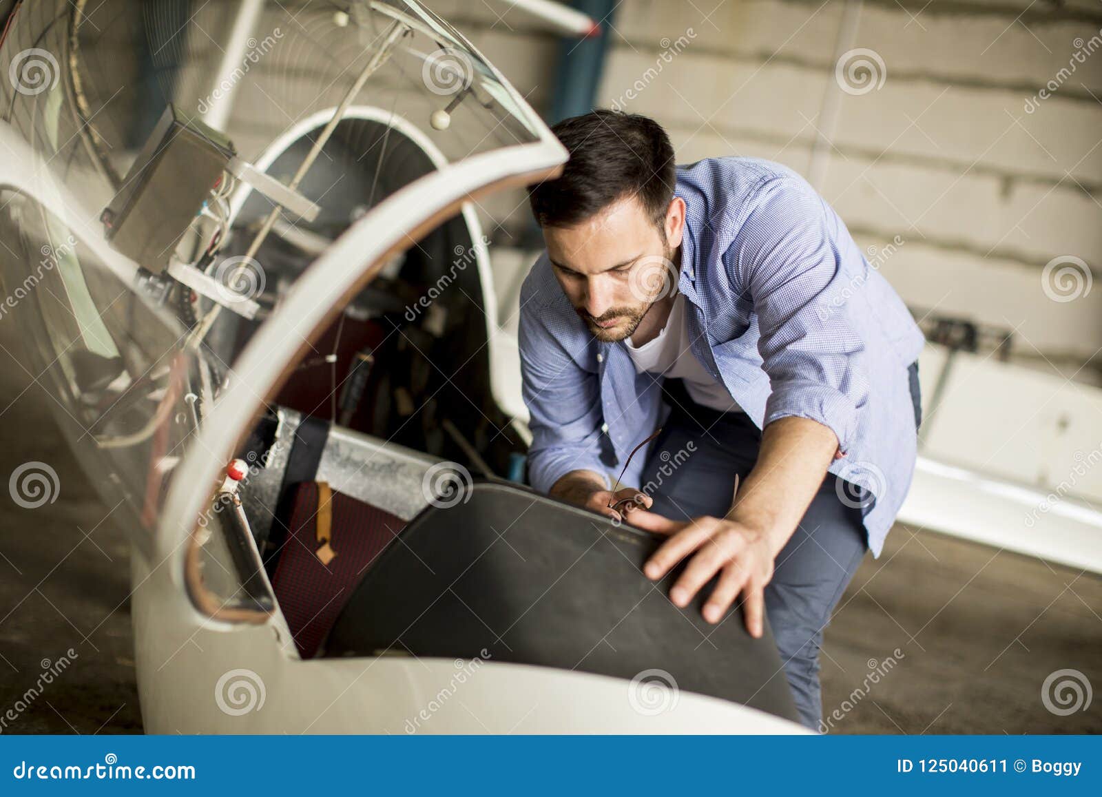 Young Pilot Checking Airplane in the Hangar Stock Image - Image of ...