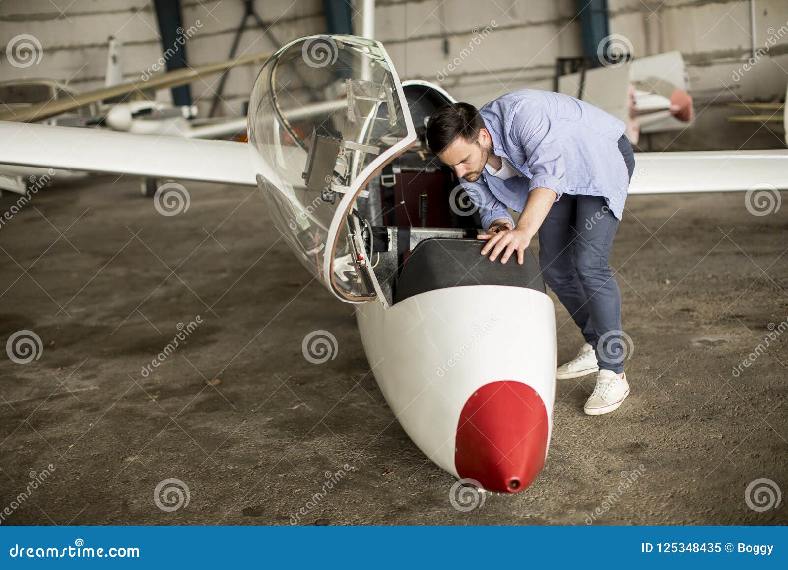 Young Pilot Checking Airplane in the Hangar Stock Image - Image of ...