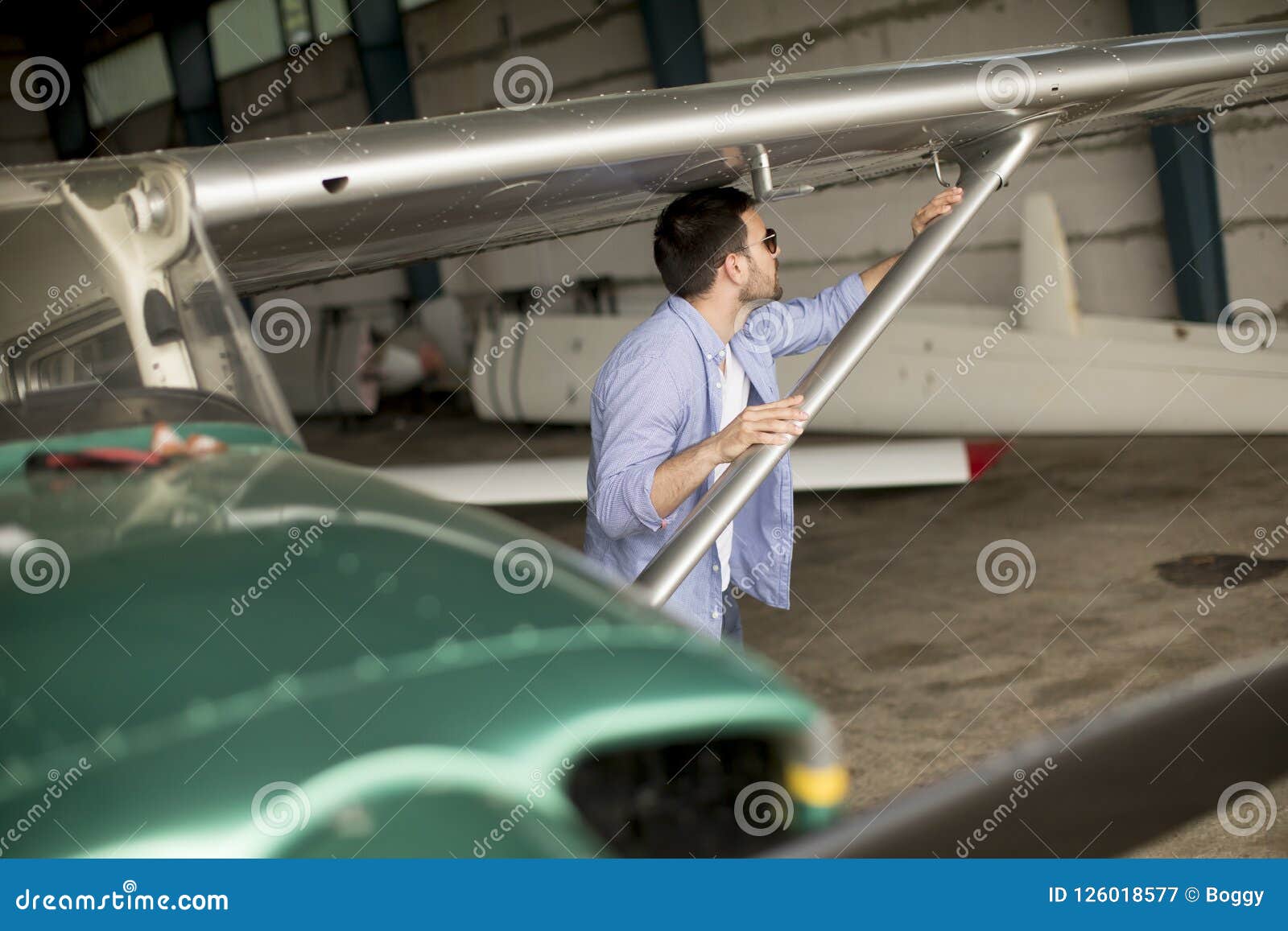 Young Pilot Checking Airplane in the Hangar Stock Image - Image of ...