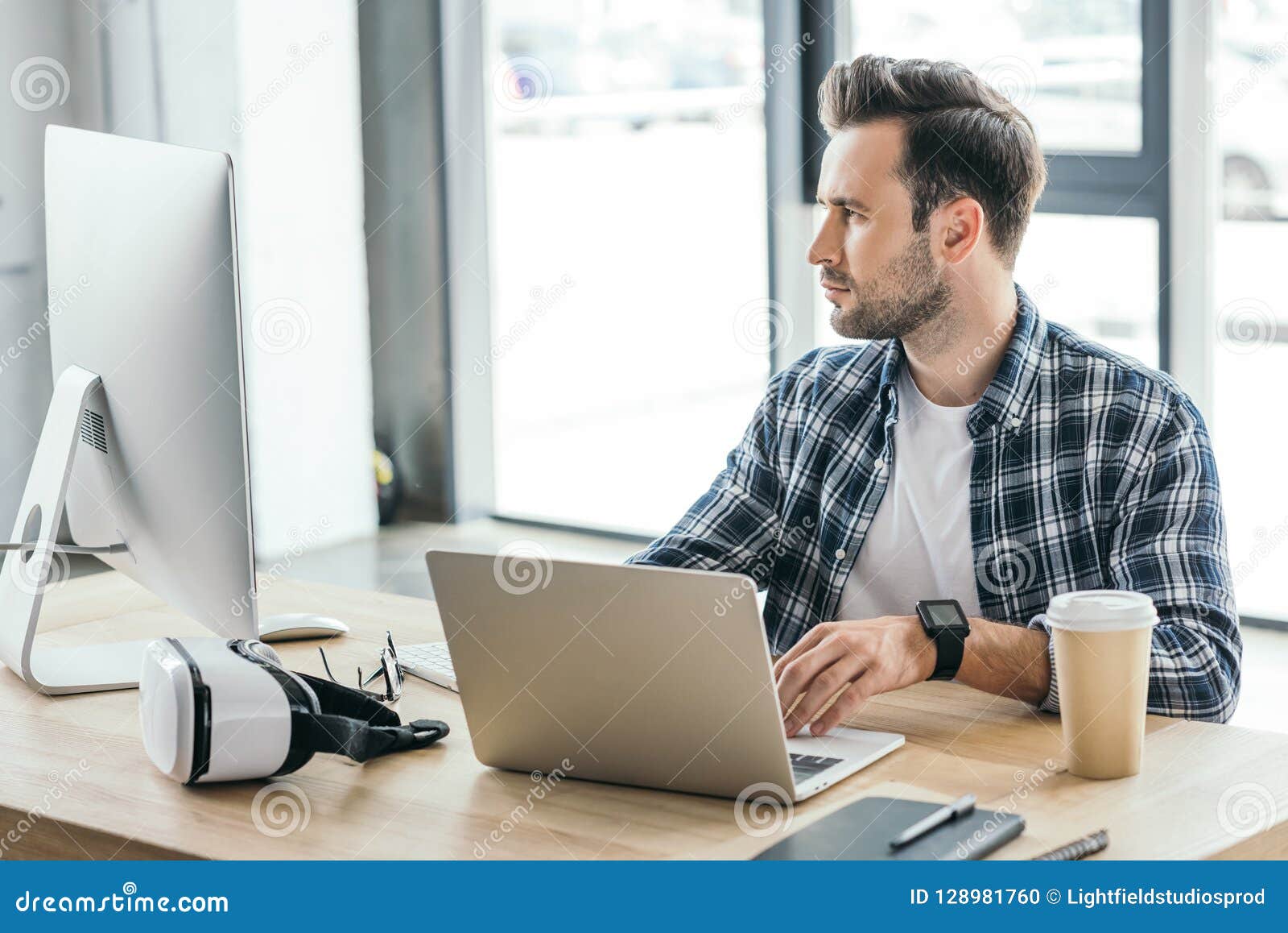 Handsome Young Programmer Using Laptop and Desktop Computer Stock Photo ...