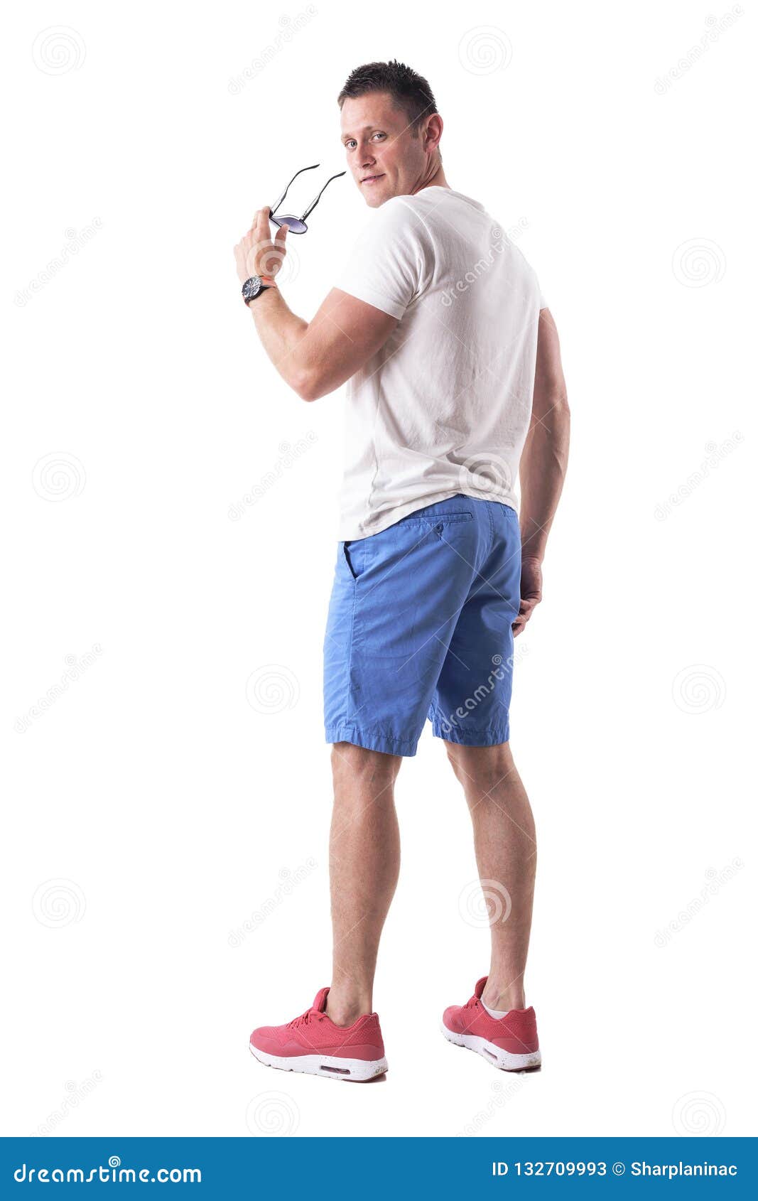Handsome Young Smiling Man Holding Sunglasses Turning Back And Looking