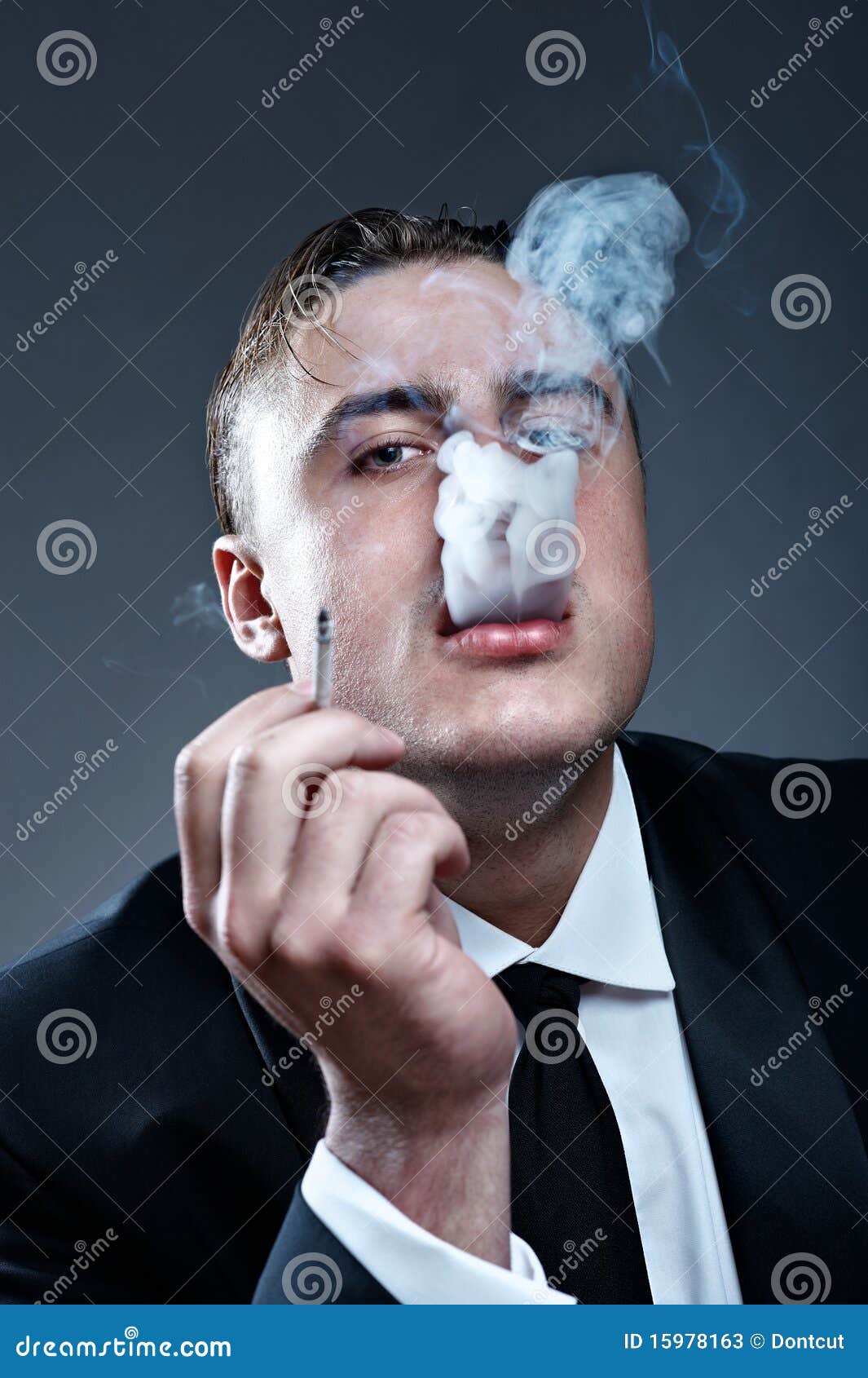 Handsome young smoker stock image. Image of adults, male - 15978163