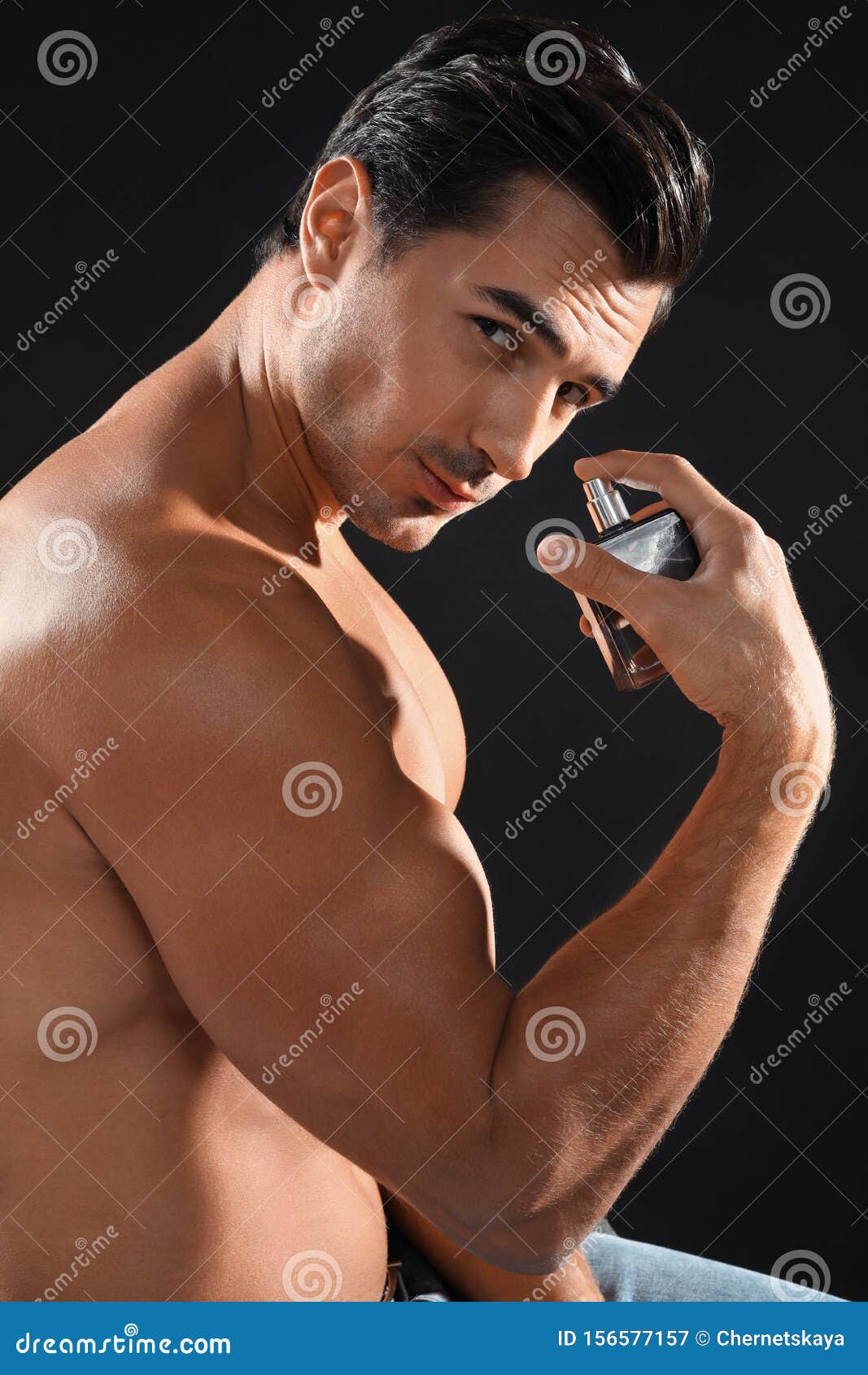 Handsome Young Using Perfume on Black Background Stock Image - Image of ...