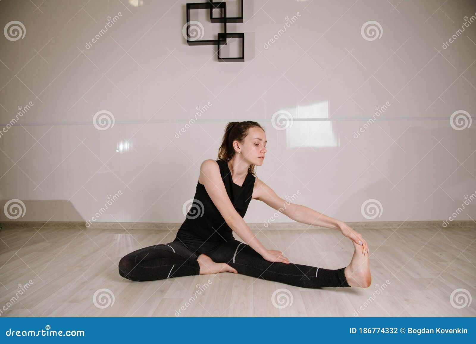 Handsome Young Woman Doing Hamstring Stretch Exercise at Home Stock ...