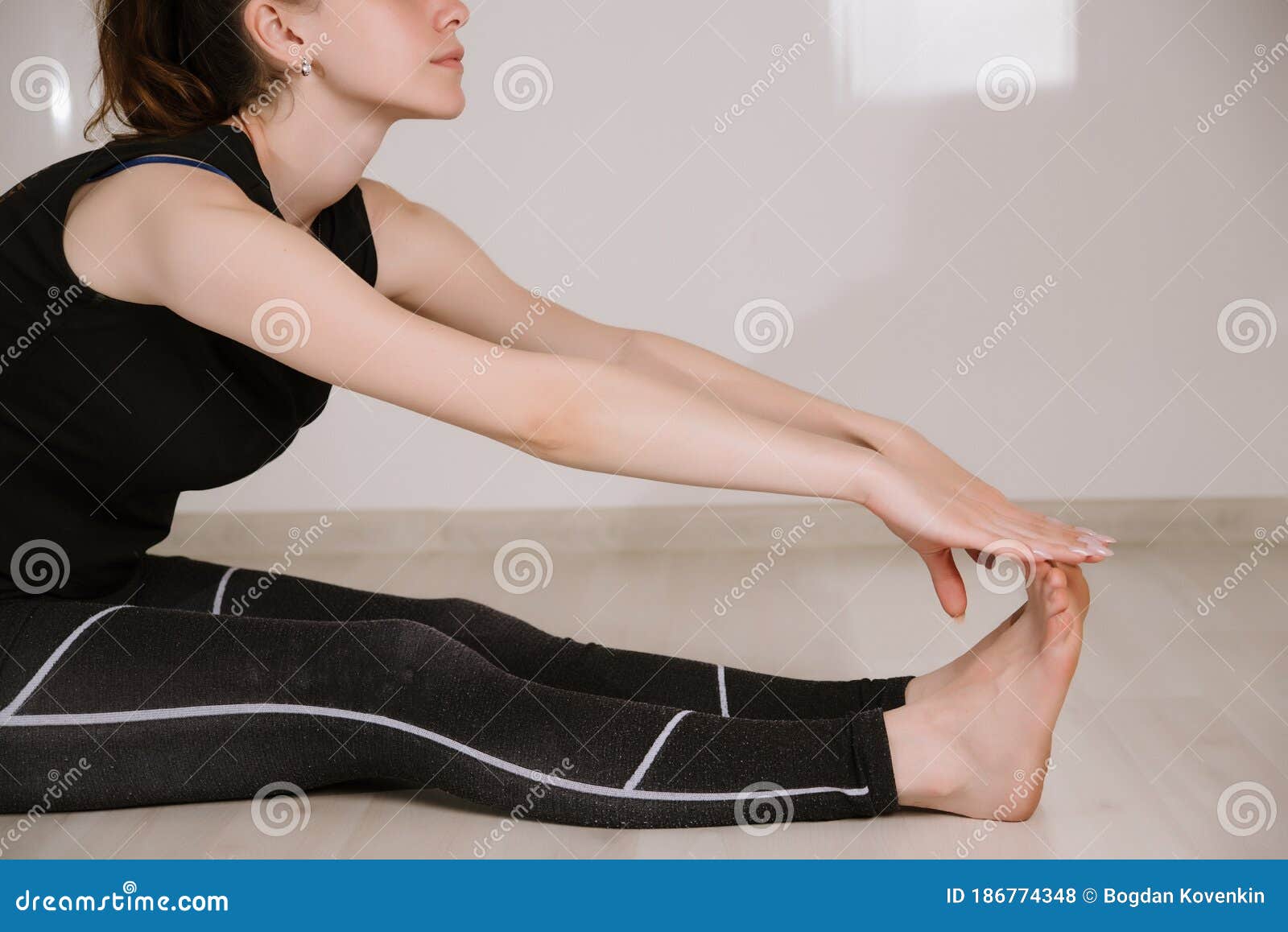 Handsome Young Woman Doing Hamstring Stretch Exercise at Home Stock ...