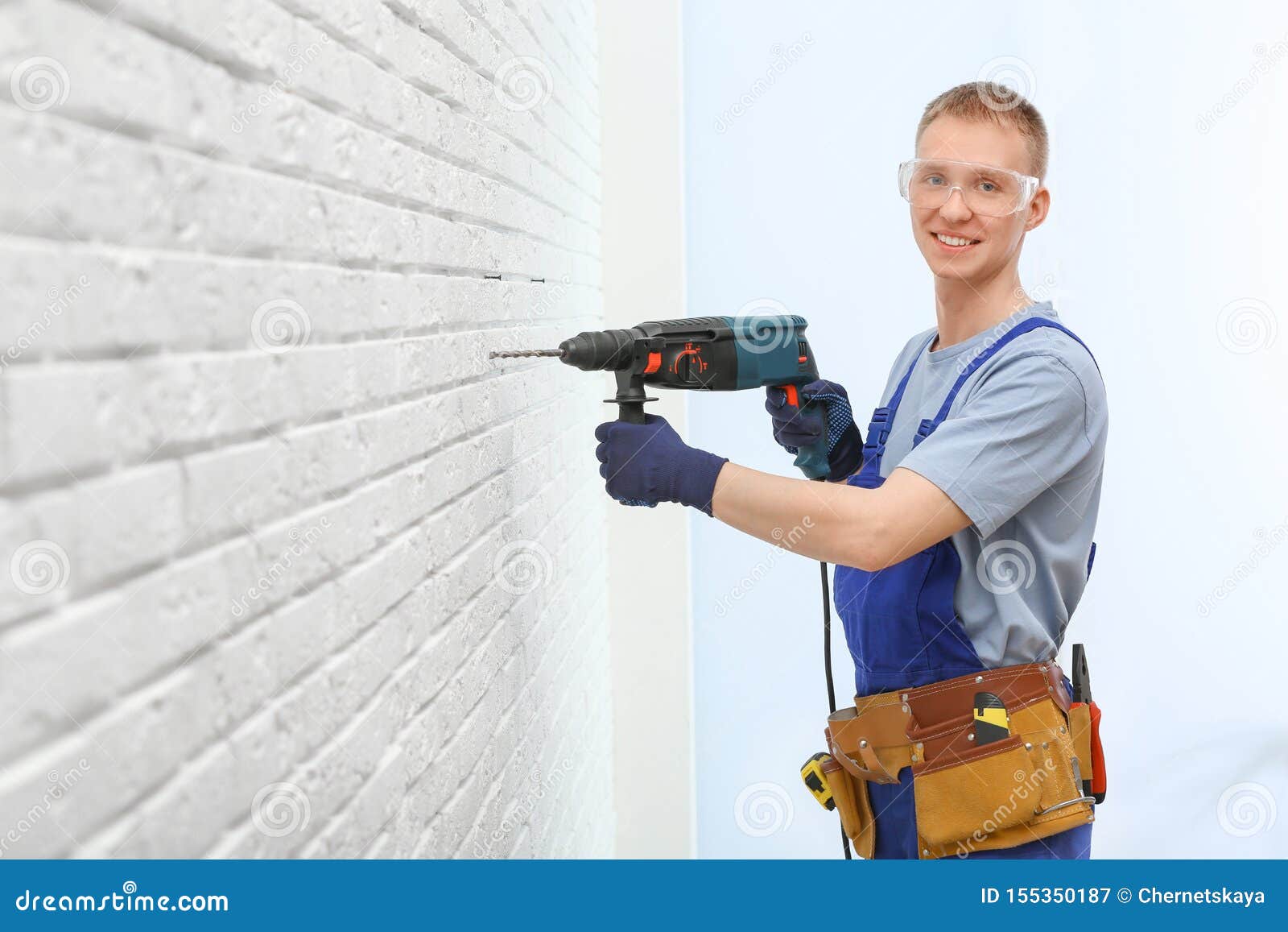 Handsome Young Working Man Using Rotary Hammer. Home Repair Stock Image ...