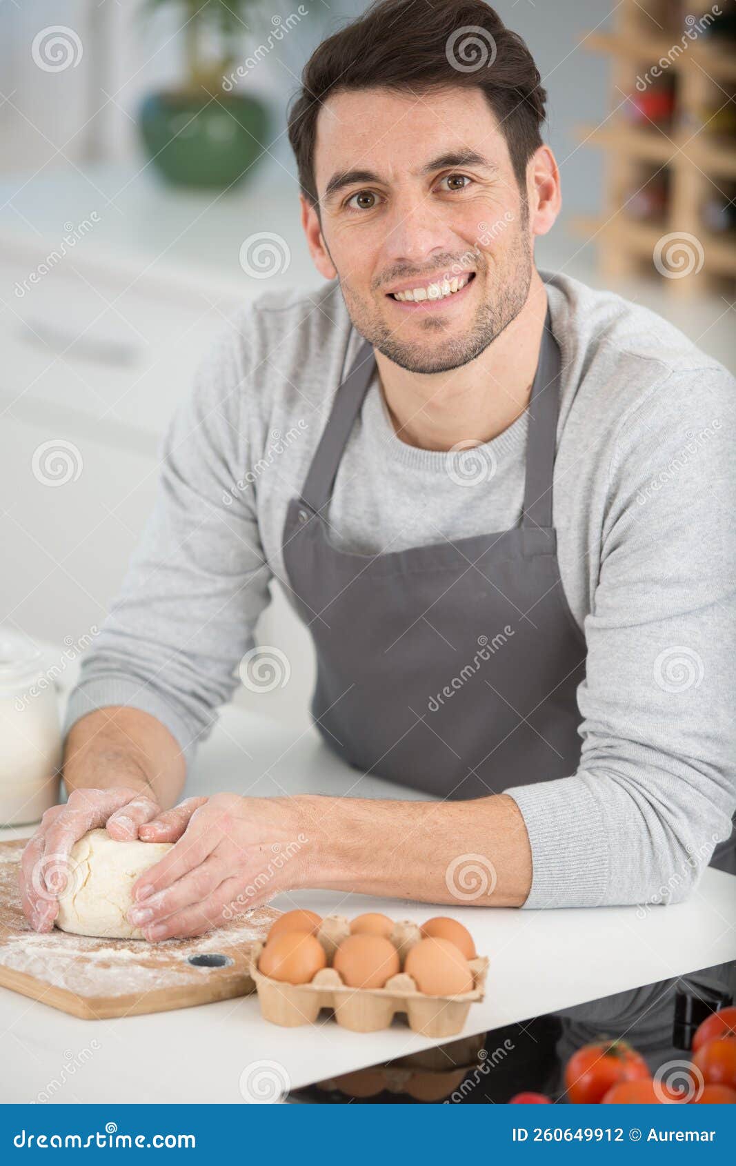 Handsomen man making dough stock photo. Image of caucasian - 260649912