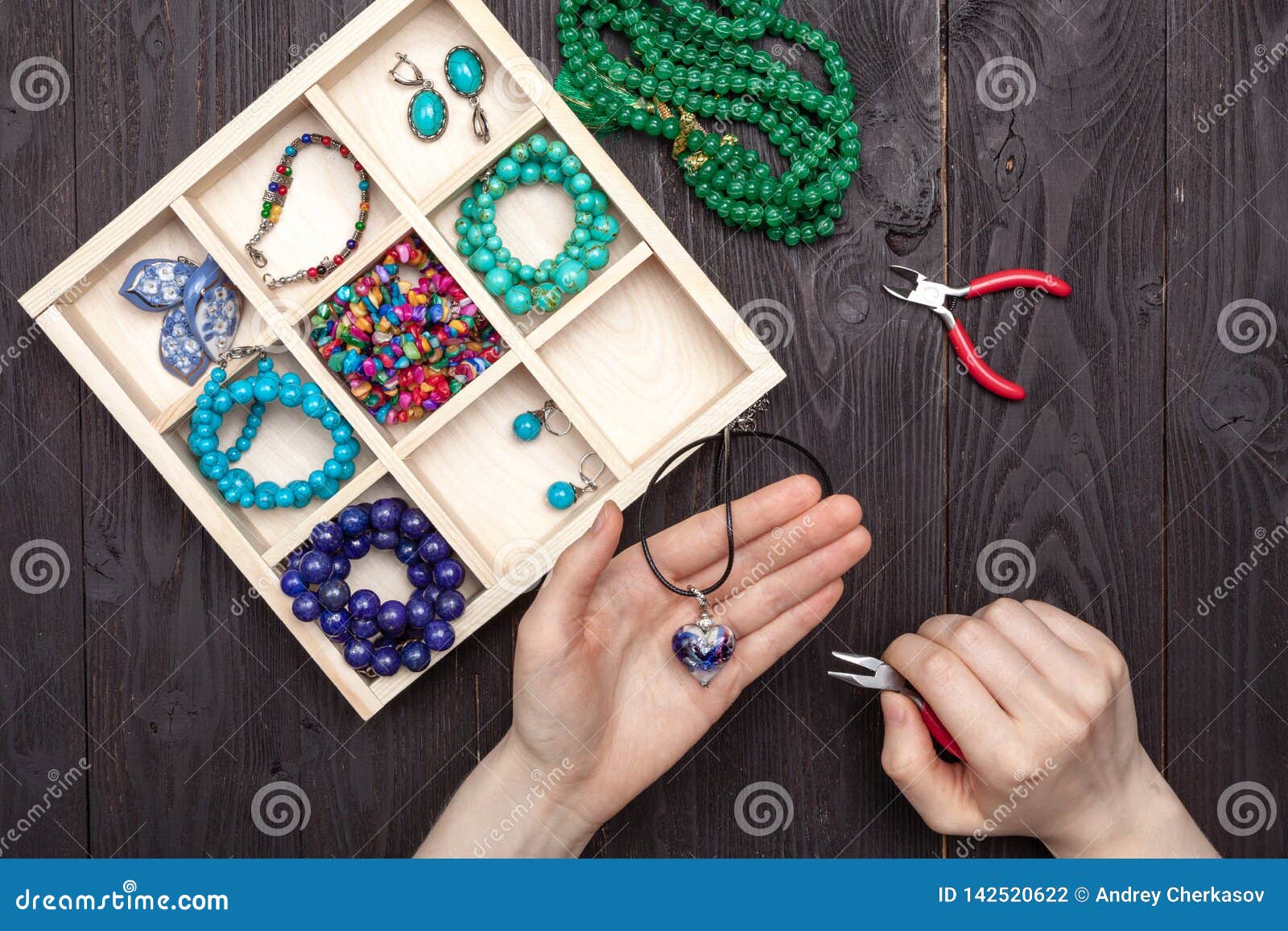 Handwork at Home, the Girl Makes Jewelry Hands on the Table Stock Photo ...