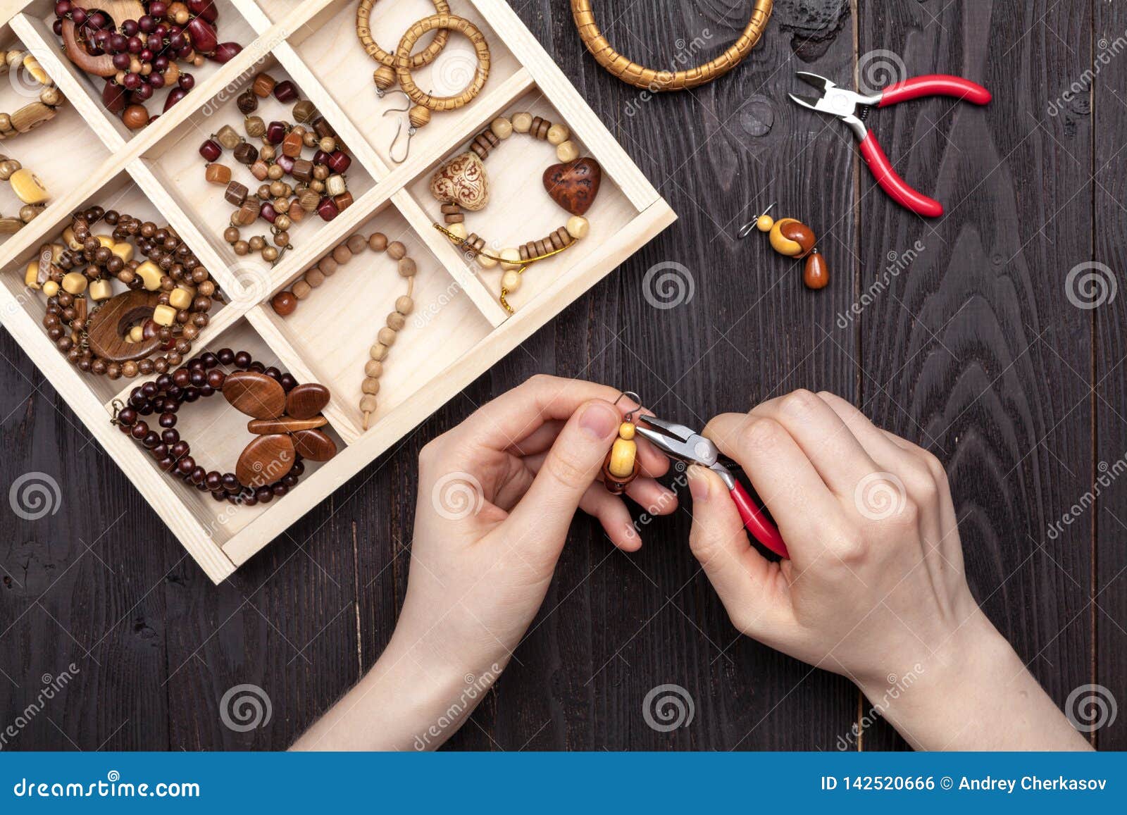 Handwork at Home, the Girl Makes Jewelry Hands on the Table Stock Photo ...